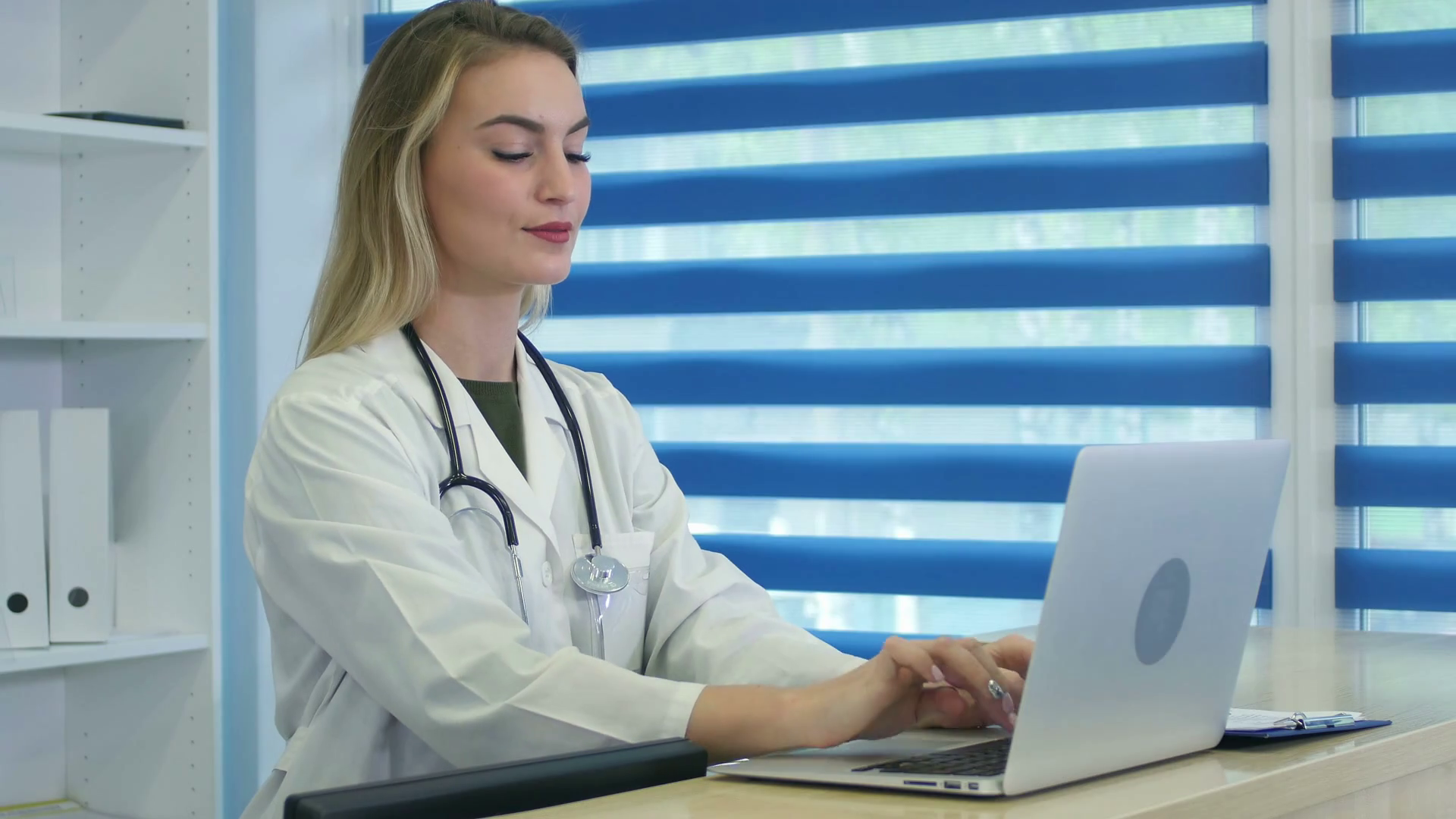 Smiling Nurse Typing On Laptop Making Notes Stock Footage SBV-315920669 ...
