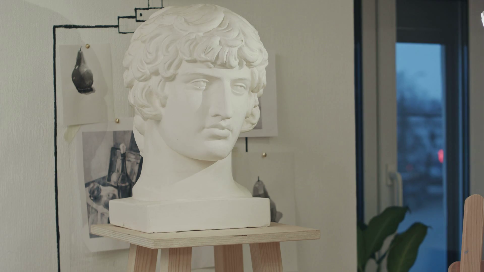 White plaster bust sculpture portrait of a young man in art studio ...