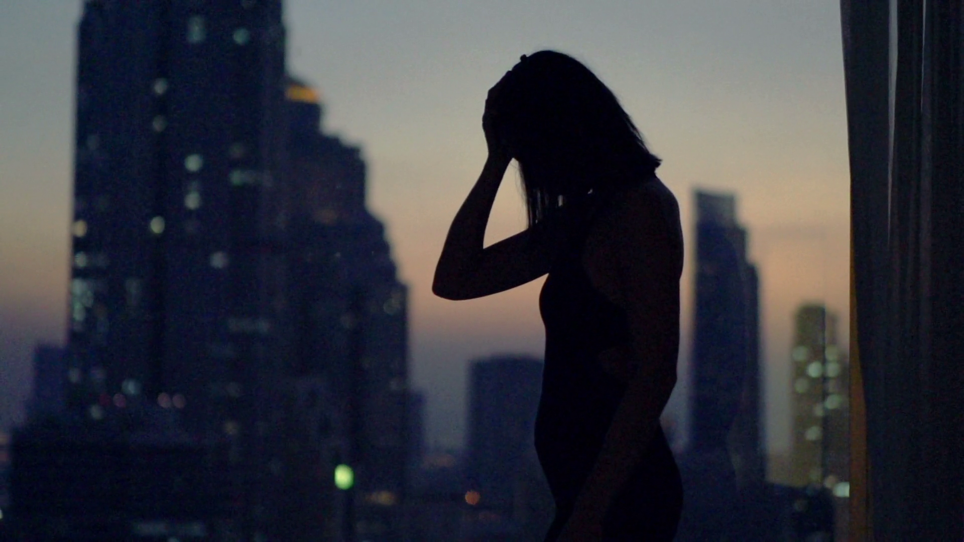 Sad, desperate woman walking by window at home at night, super slow ...