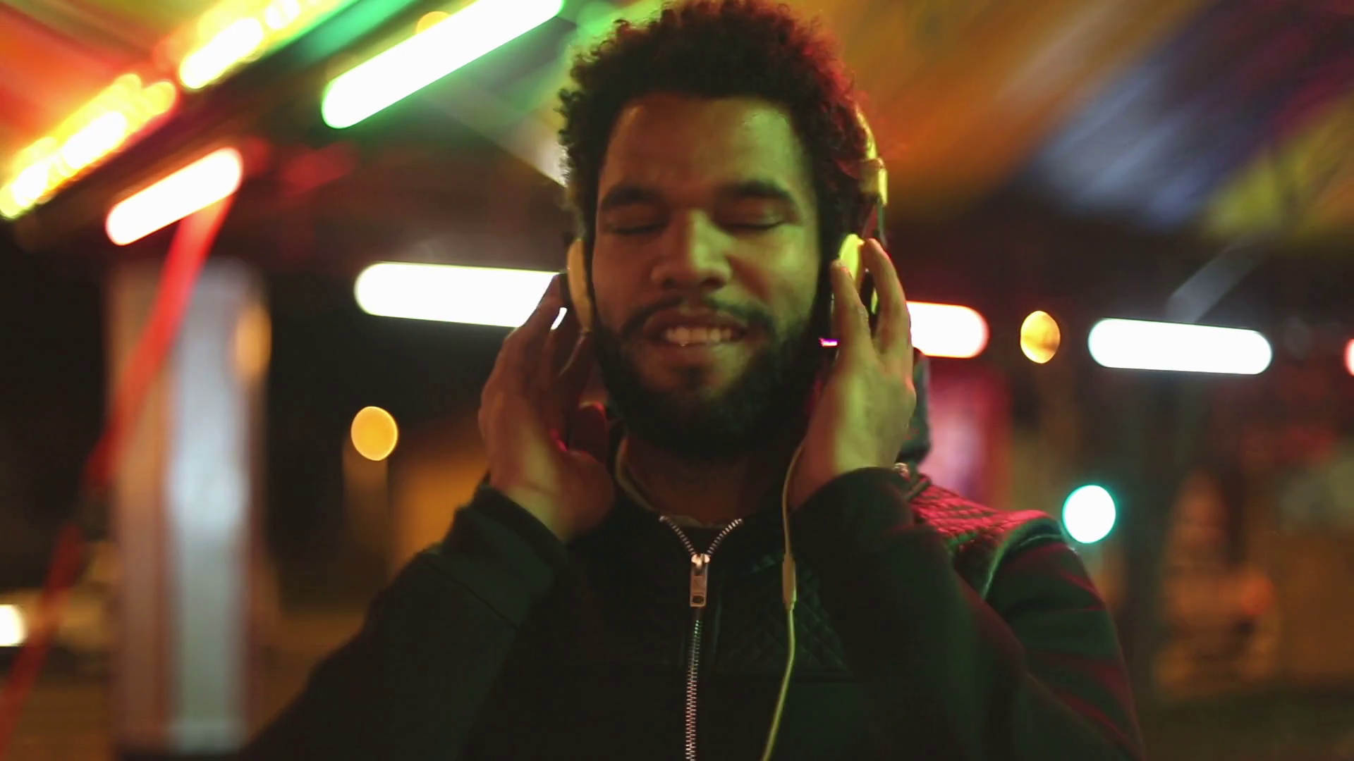 Handsome young man dancing to the rhythm of music with headphones at ...