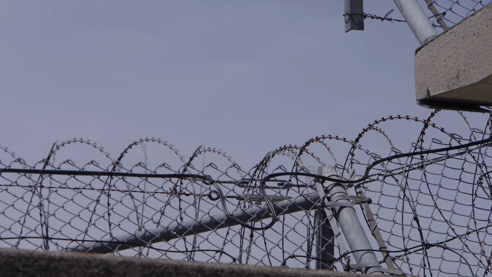 Prison Exterior Tilt Up To Messy Barbed Wire Stock Footage SBV ...