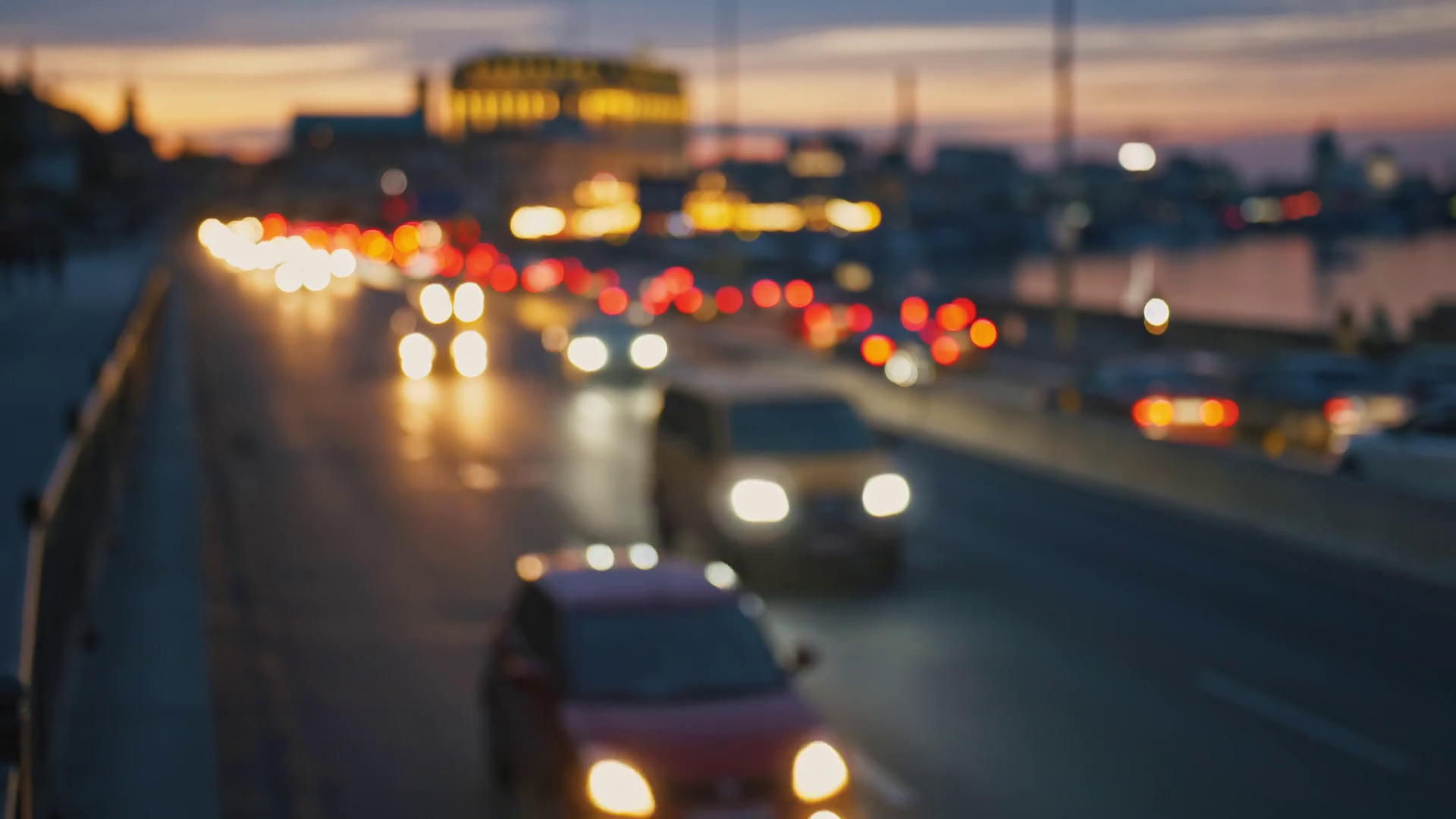 Blurred busy city traffic background with glowing headlights of moving ...