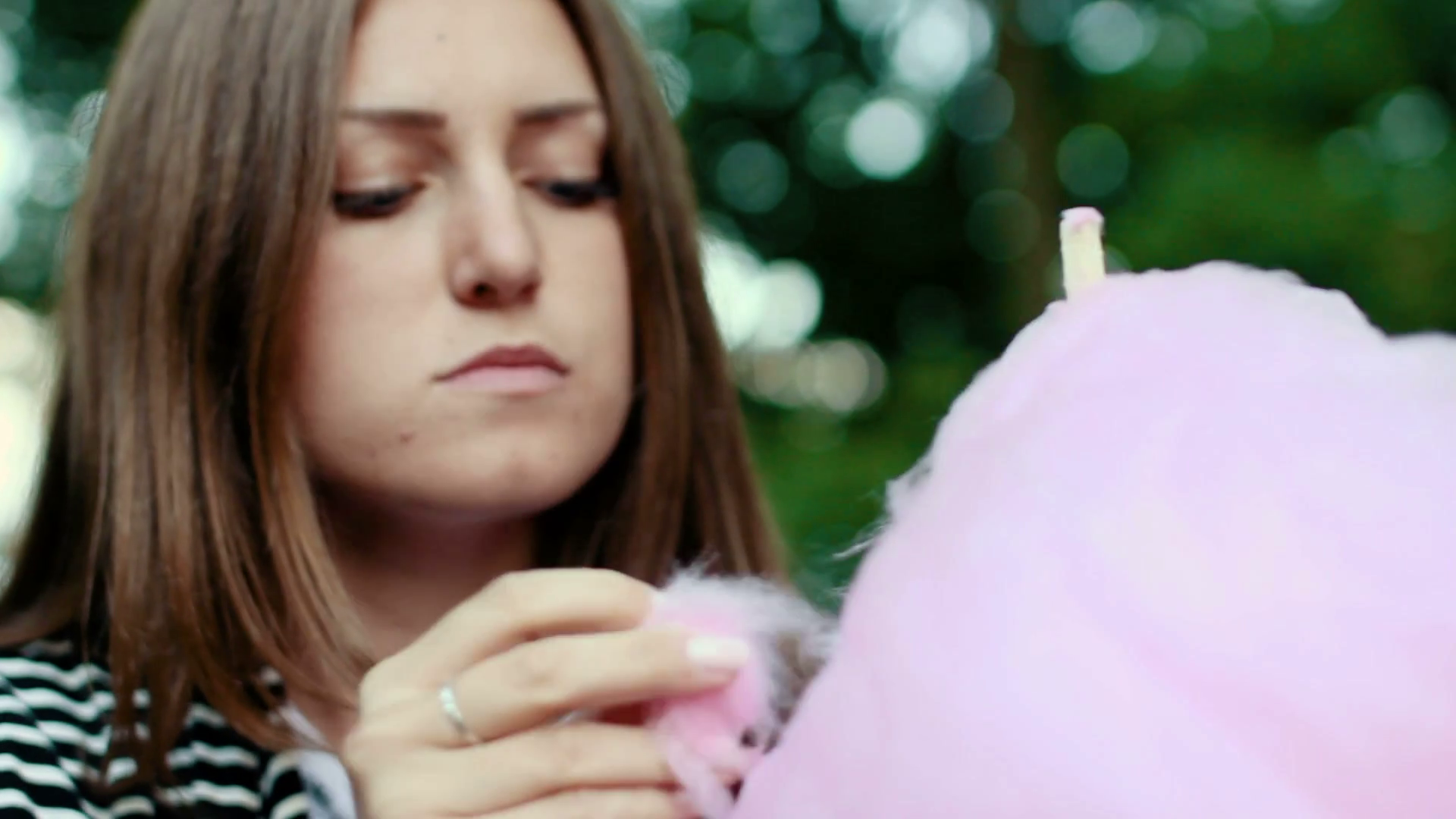 Young Woman Eating Cotton Candy In Park Stock Footage SBV-338415212 ...