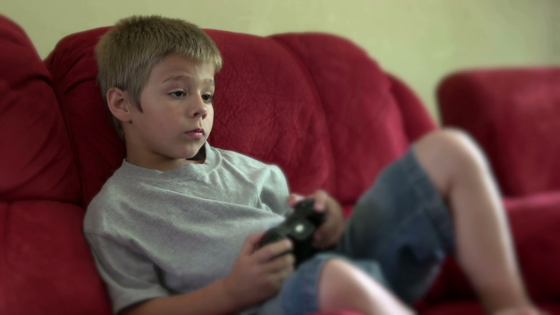 Child Playing Video Game Sitting On Couch Stock Footage SBV-301159208 ...