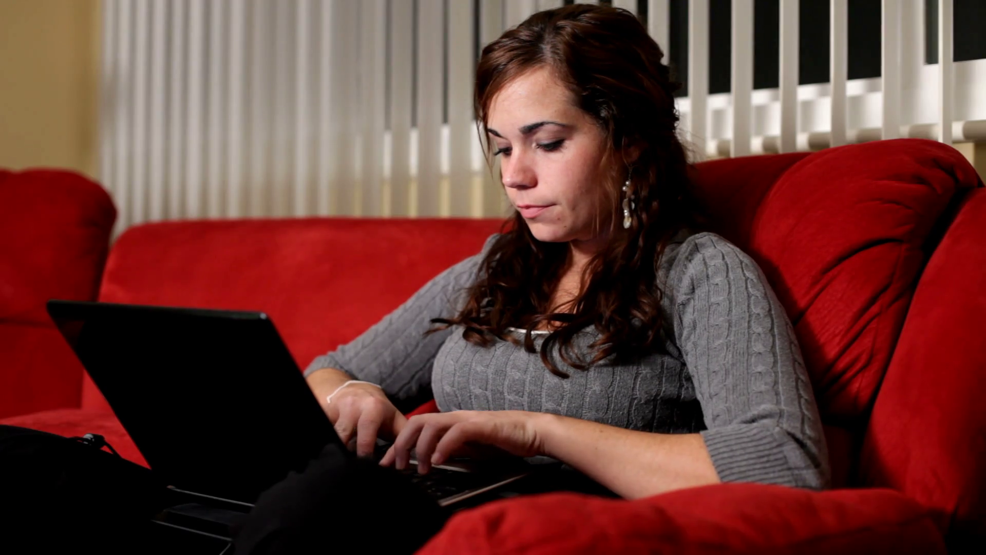 Girl using computer on red couch Stock Video Footage 00:16 SBV ...