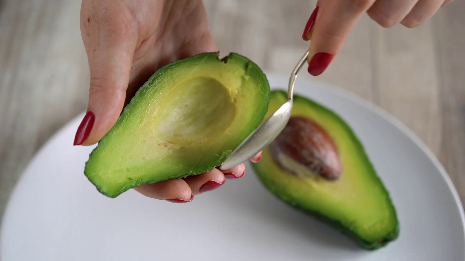 Woman Takes Out Pulp Of Avocado From Peel Stock Footage SBV-332474417 ...