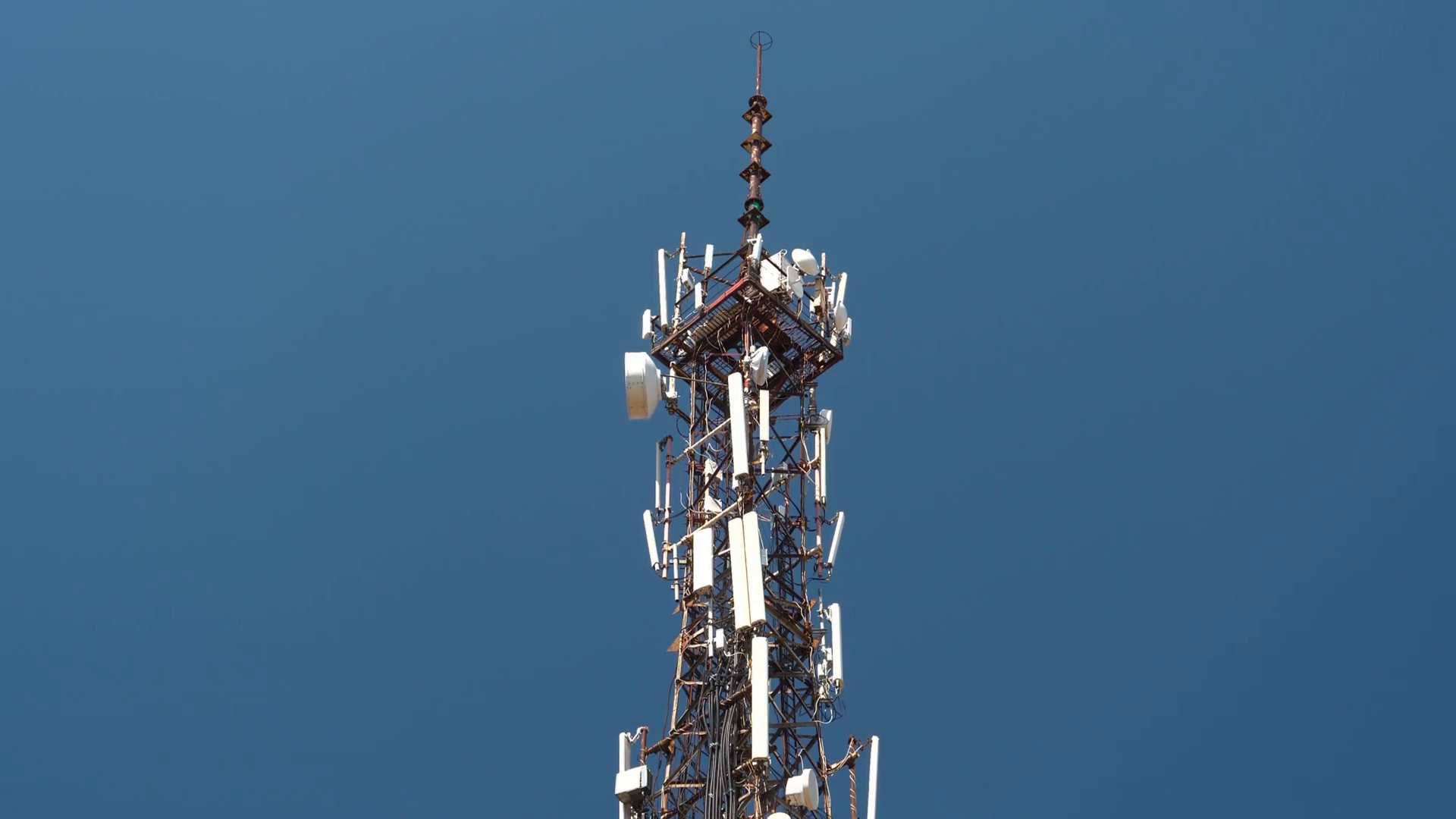 Zoom-out view of cell tower on blue background Stock Video Footage 00: ...