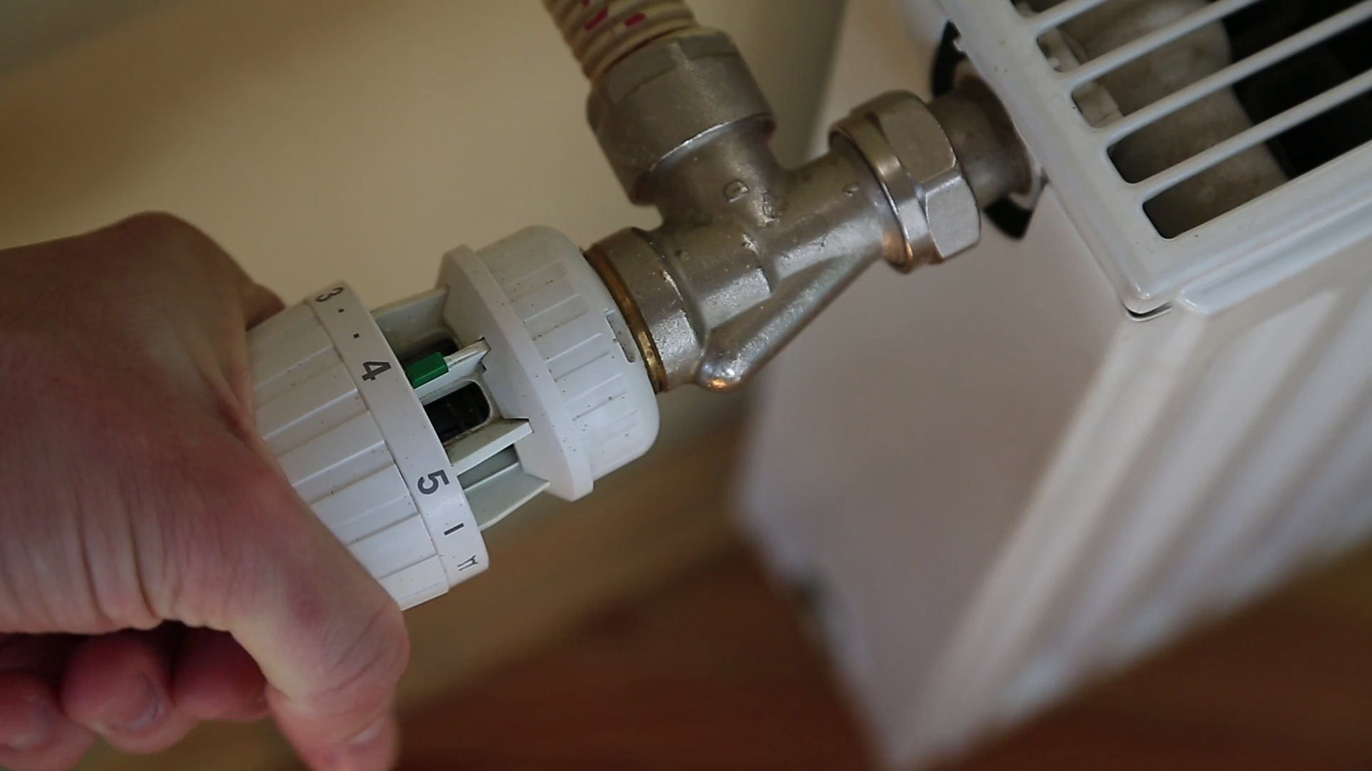 Man adjusts the temperature of the battery. Central heater with ...