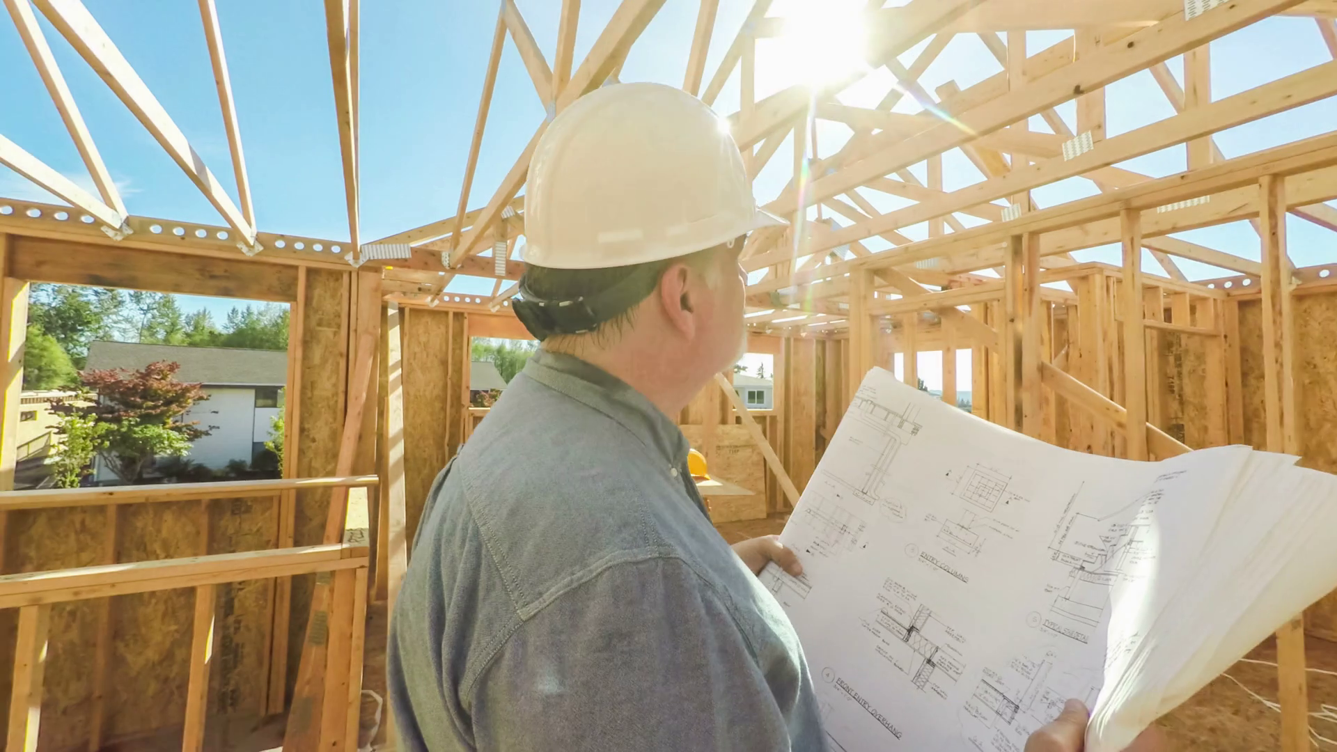 Construction worker on site with building plans, circling Stock Video ...