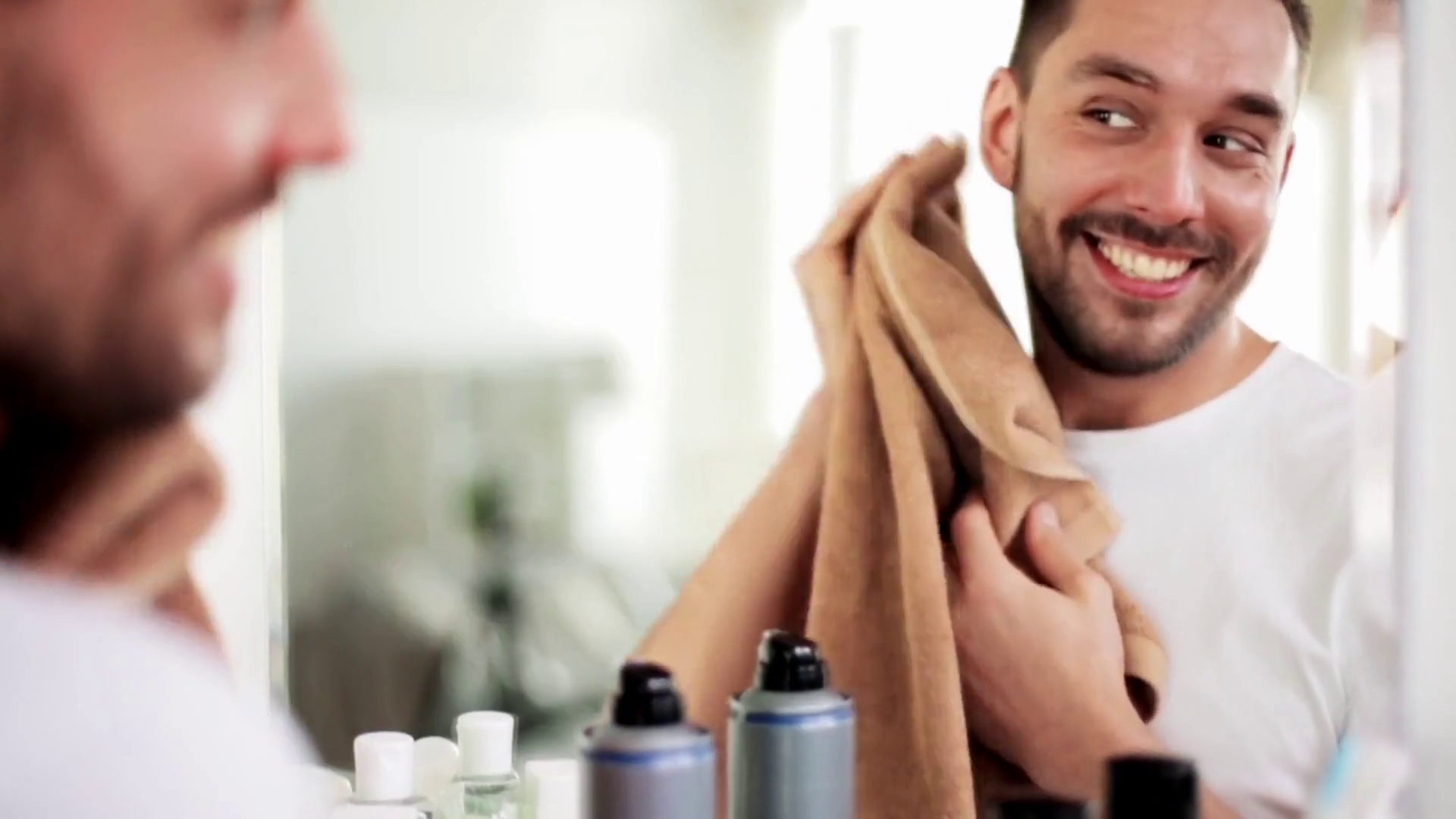 beauty, washing and people concept - man wiping his face with towel at ...