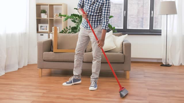 Man Sweeping The Floor