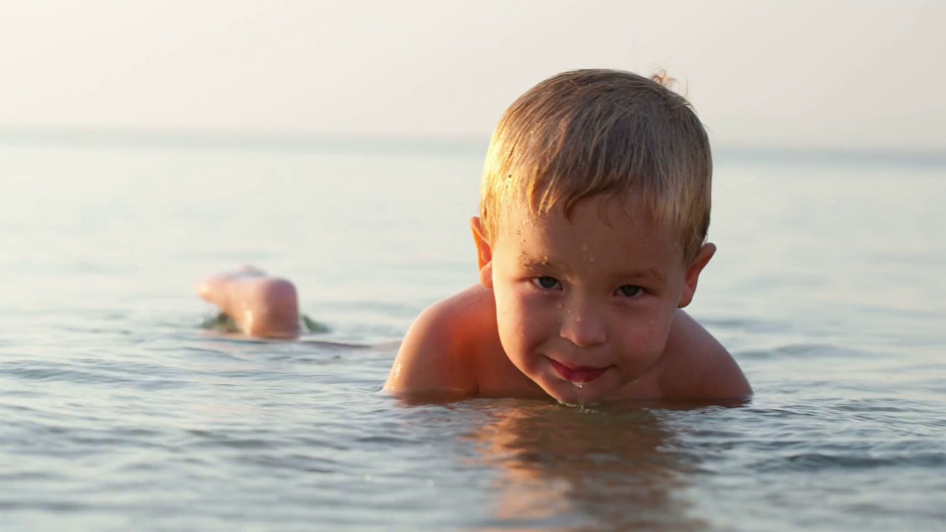Smiling Little Boy Ducking Down In Shallow Stock Footage SBV-300215415 ...