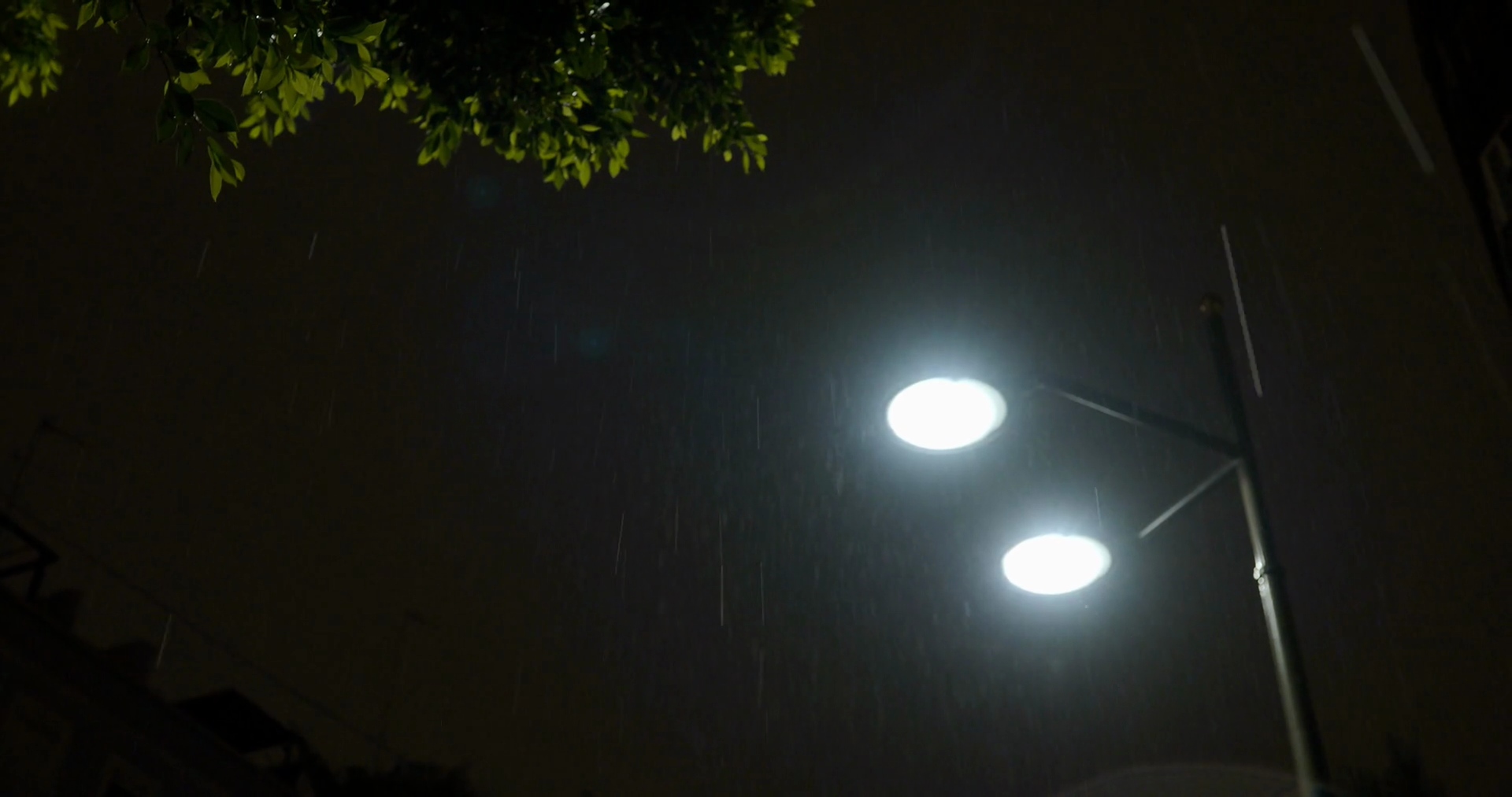 Low angle shot of street lantern with bright light against the night ...