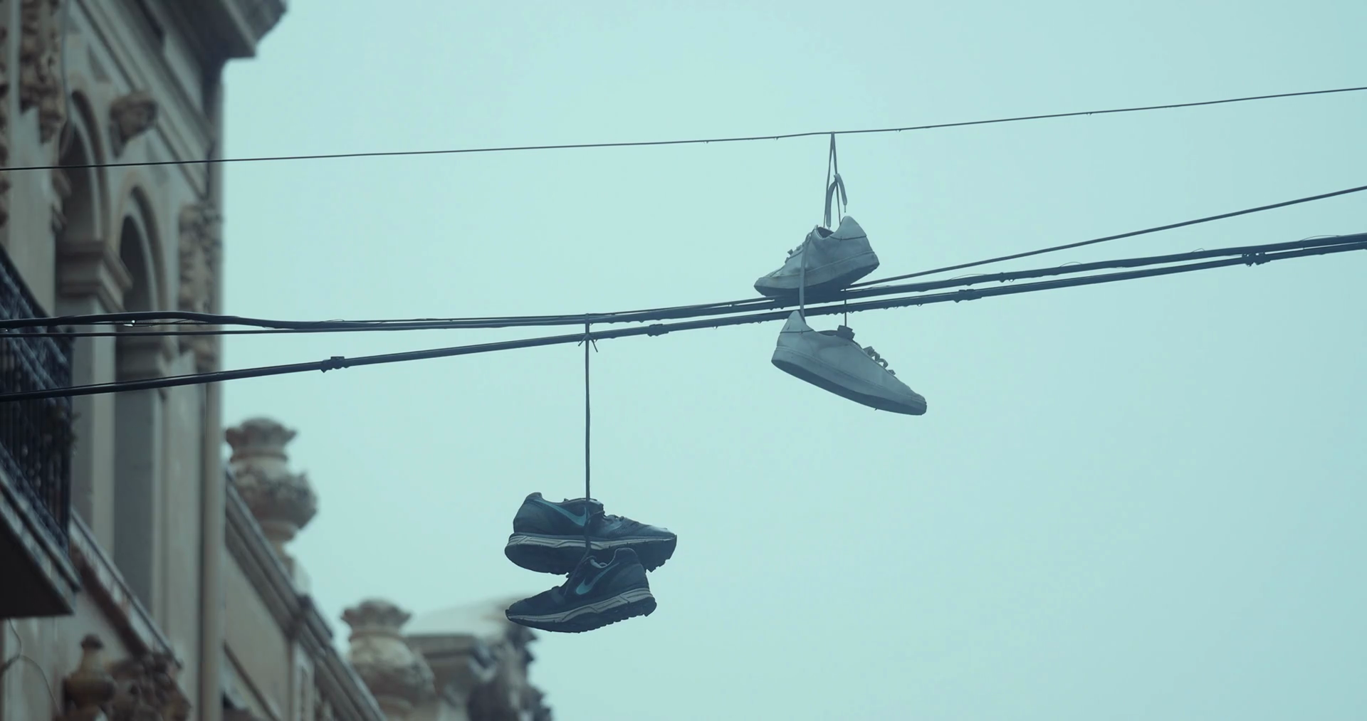 A Pair Of Sneakers Hangs From Electric Wires Stock Footage SBV ...