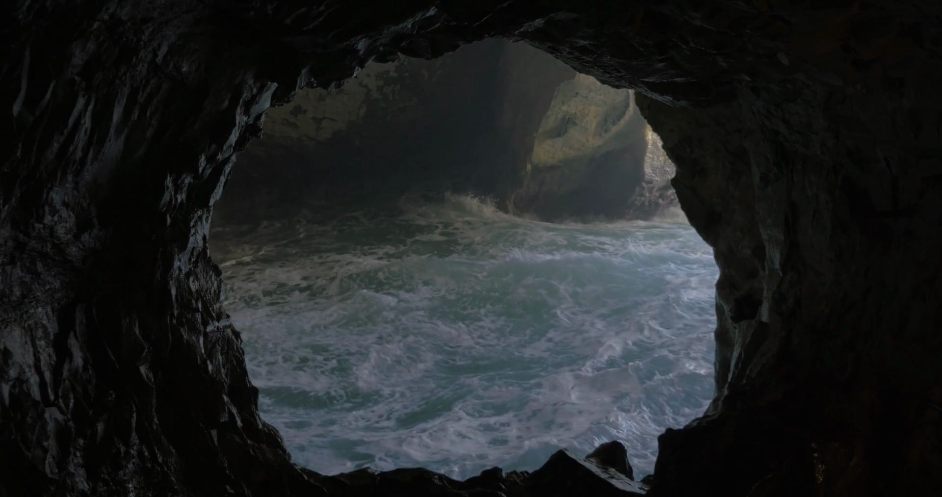 View to rough water stream from the dark sea caves. Rosh Hanikra nature ...
