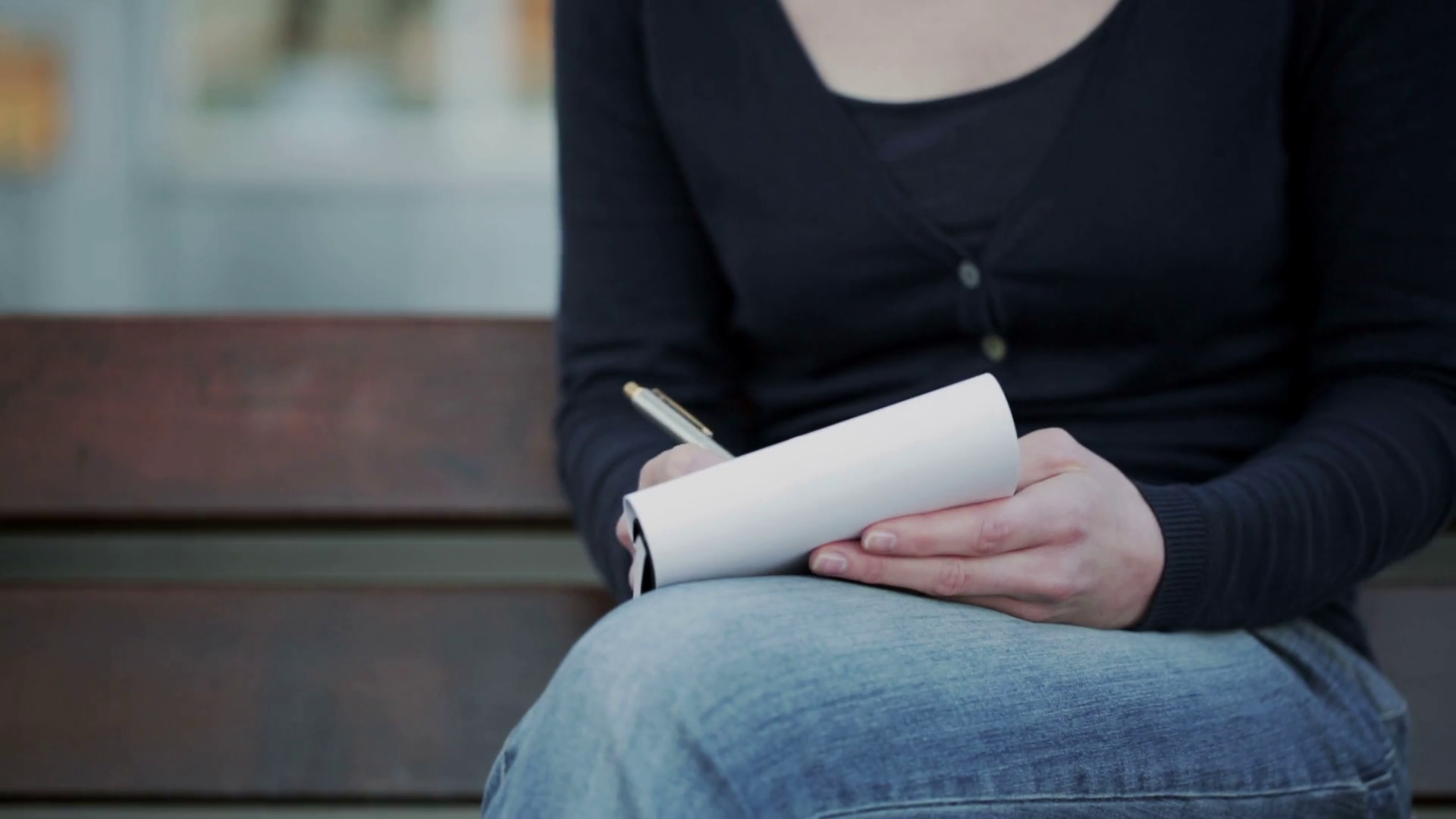 A Person Writes On Notebook In Urban Setting Stock Footage SBV ...