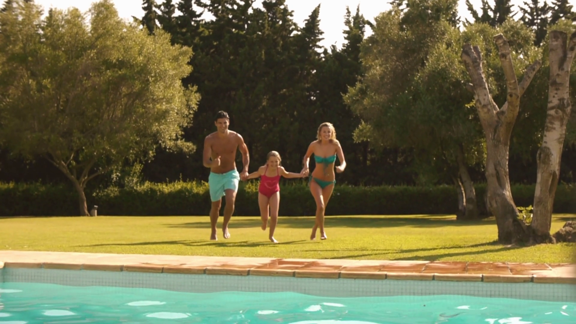 Slow motion of family jumping in pool. Stock Video Footage - Storyblocks