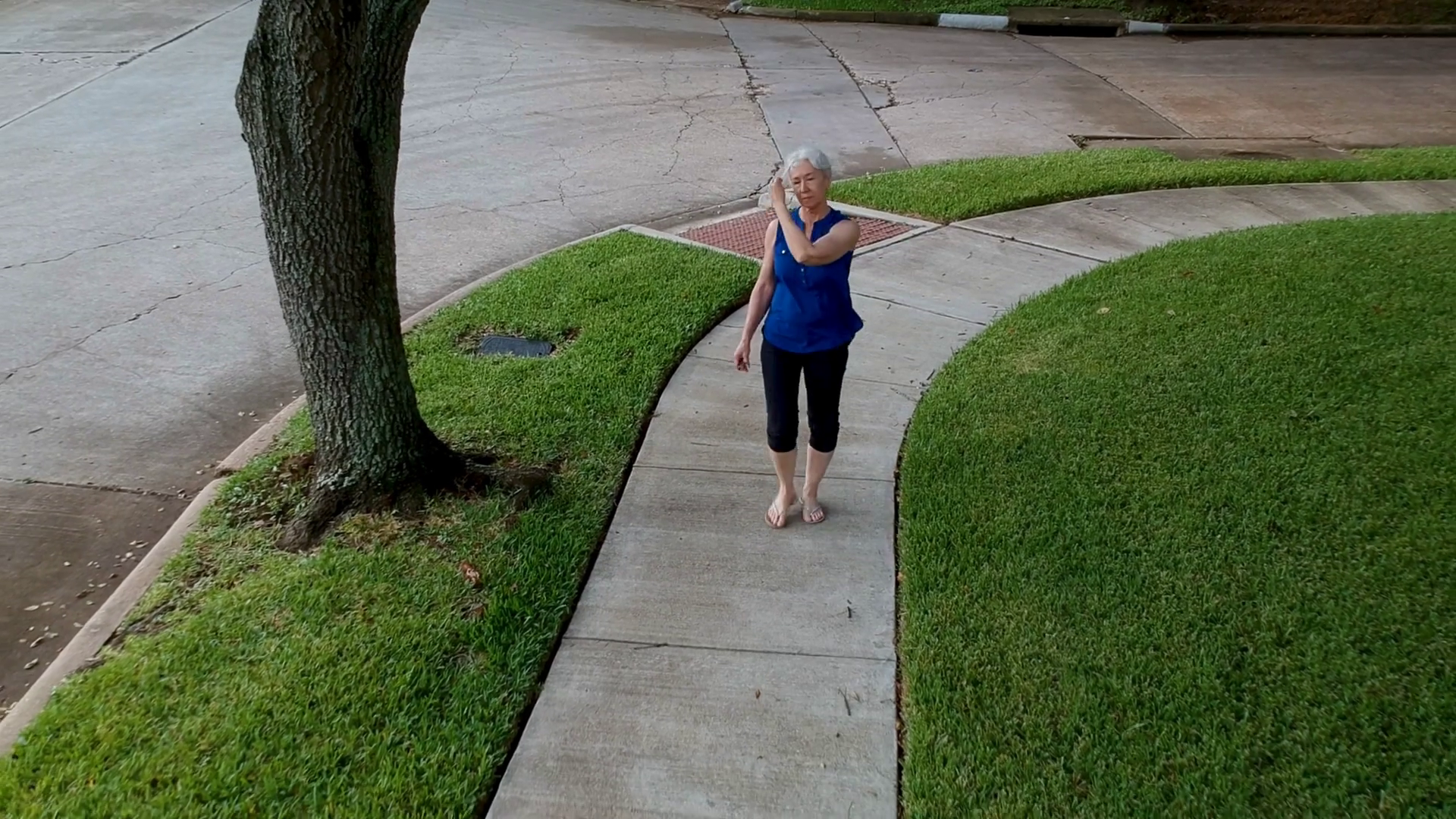 overhead pull back shot of woman walking on a sidewalk Stock Video ...