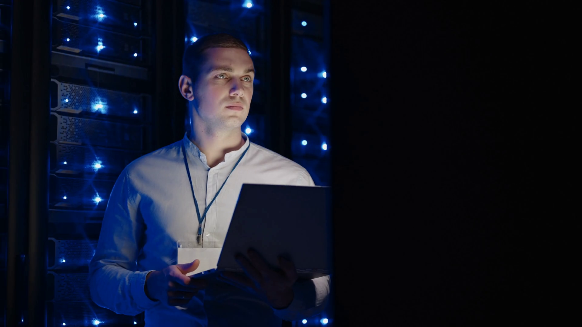 A computer engineer looks at and fixes server room problems. Modern IT ...