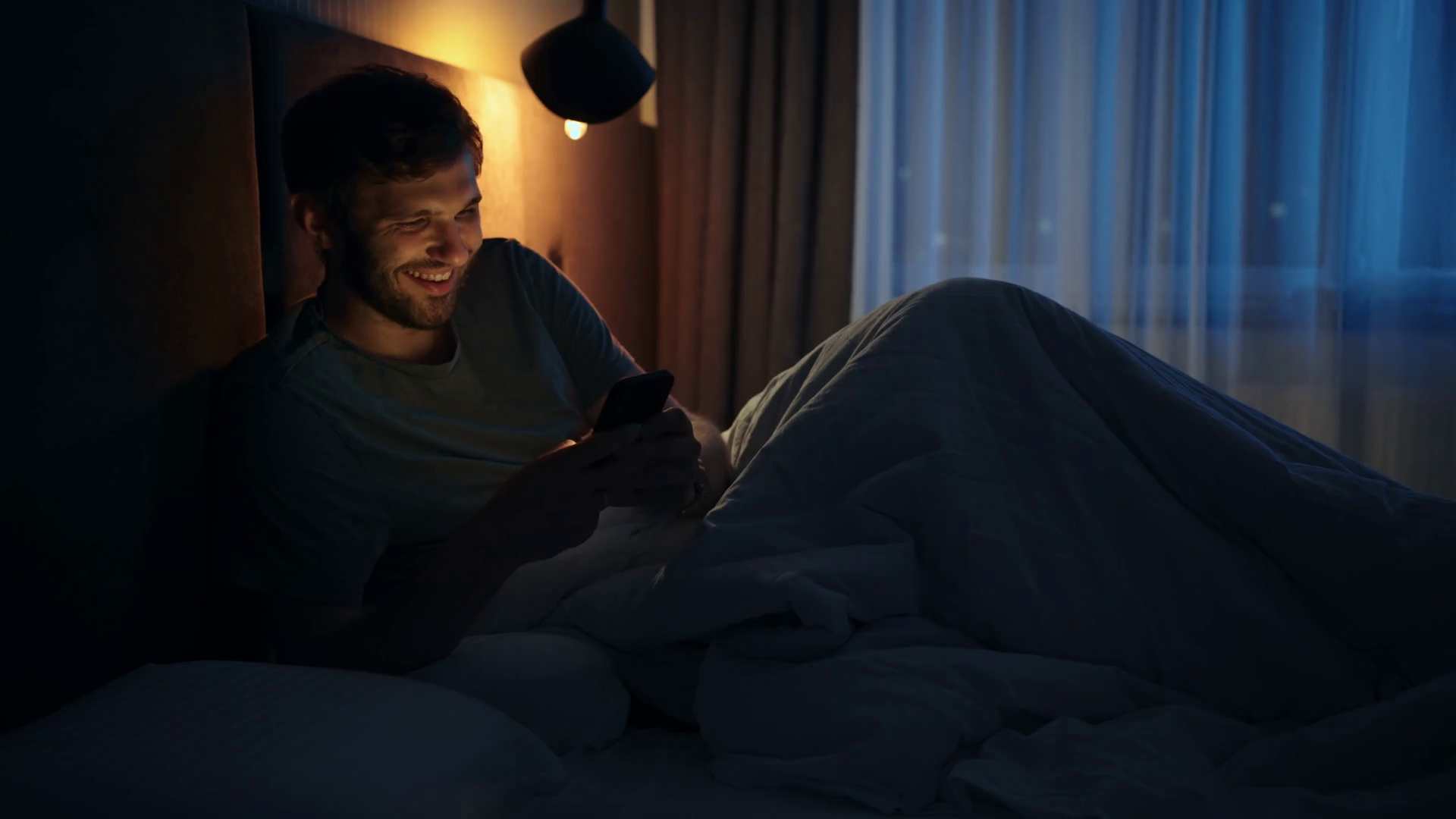 habit of using internet in smartphone before sleep, man is viewing ...