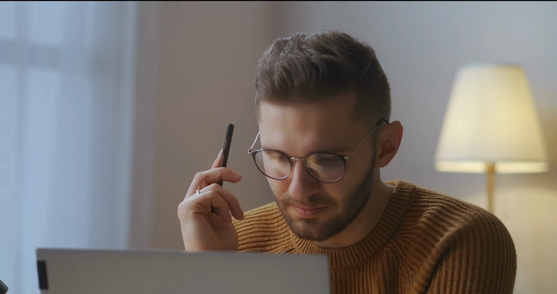 adult male student is listening online webinar or lecture on display of ...