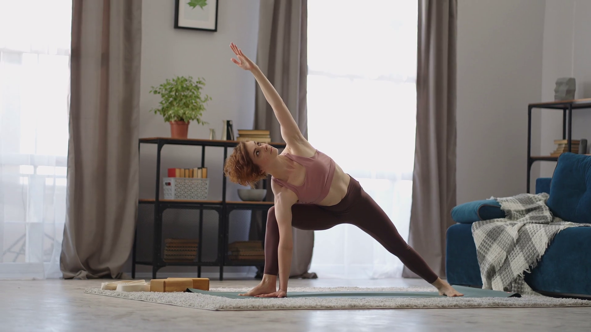 adult sporty woman is performing asana, practicing hatha yoga at home ...