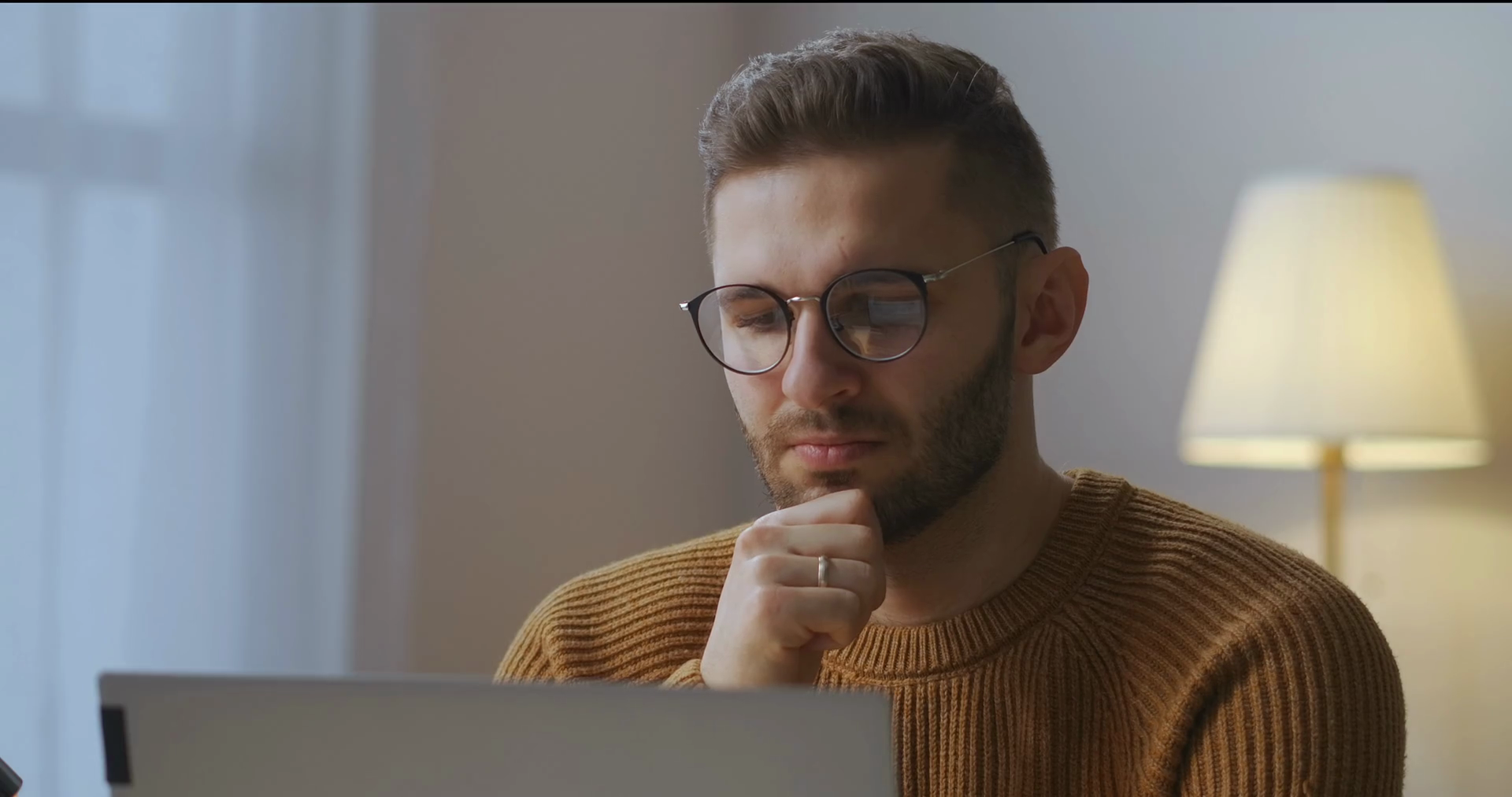 boring man with glasses is listening and looking at screen during ...