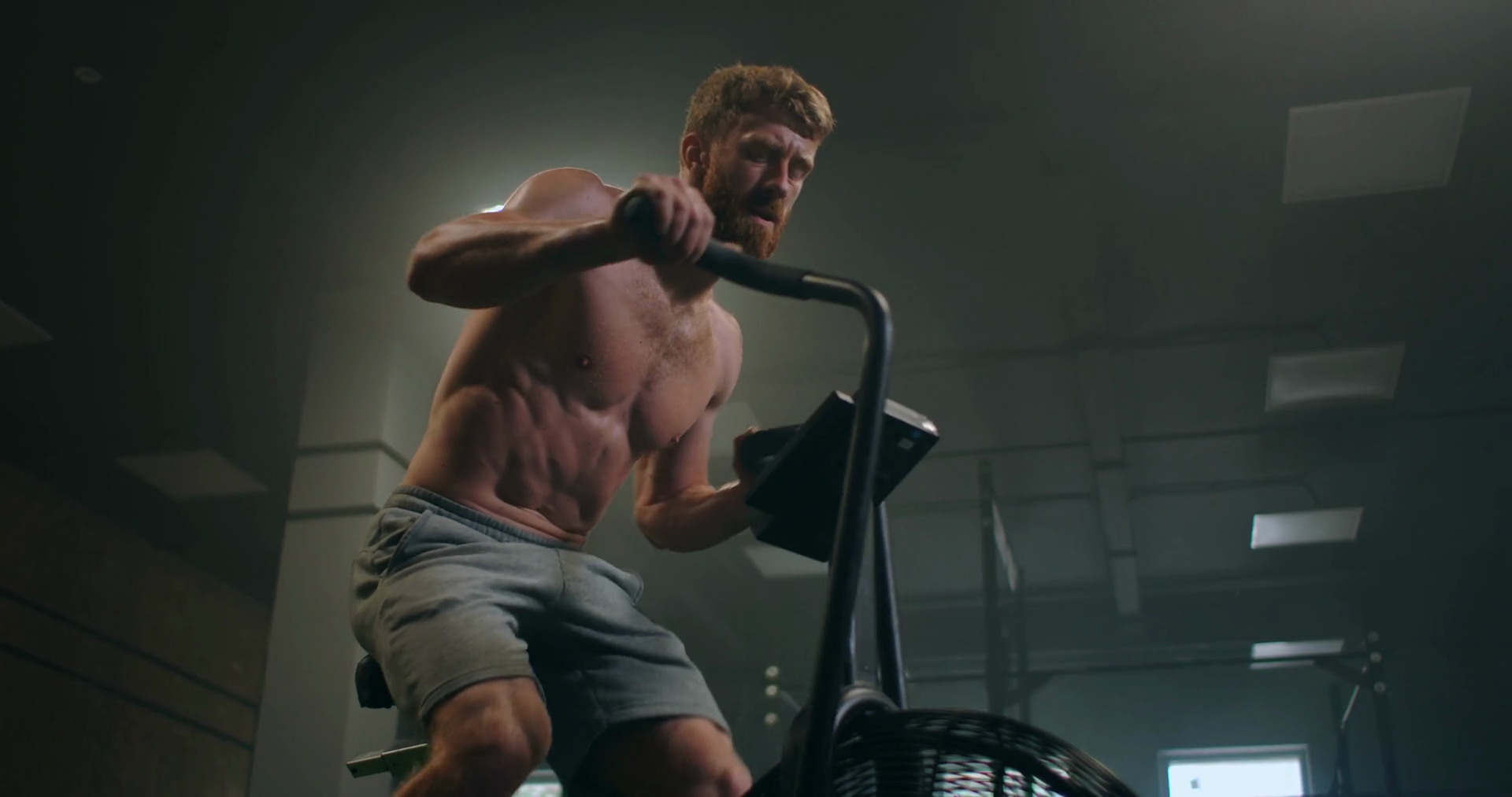 Fitness man on bicycle doing spinning at gym. Fit young male working ...