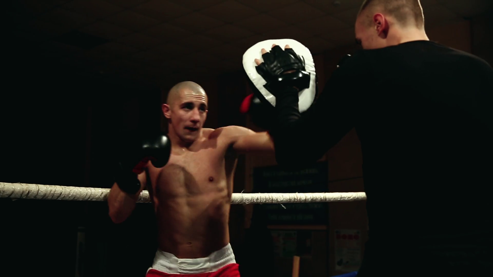 Intensive training for the boxer to work out punches with the coach ...