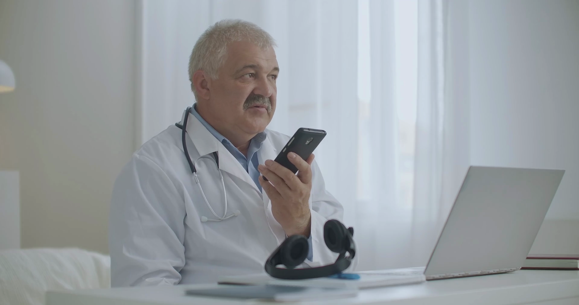 Male Doctor Is Talking Speakerphone In Stock Footage SBV-338714833 ...