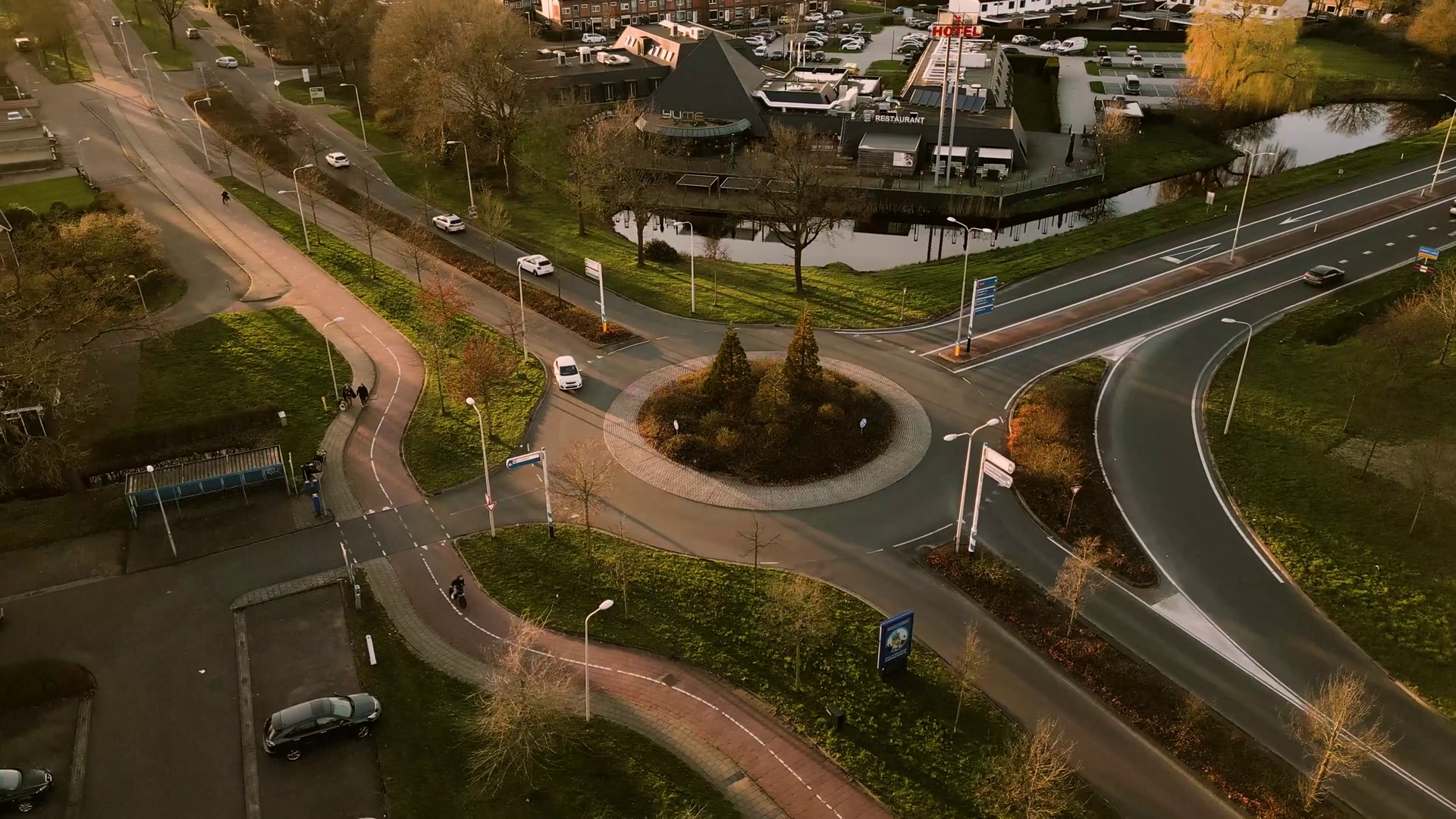 Cars Navigating Roundabout At Sunset In Stock Footage SBV-351941156 ...