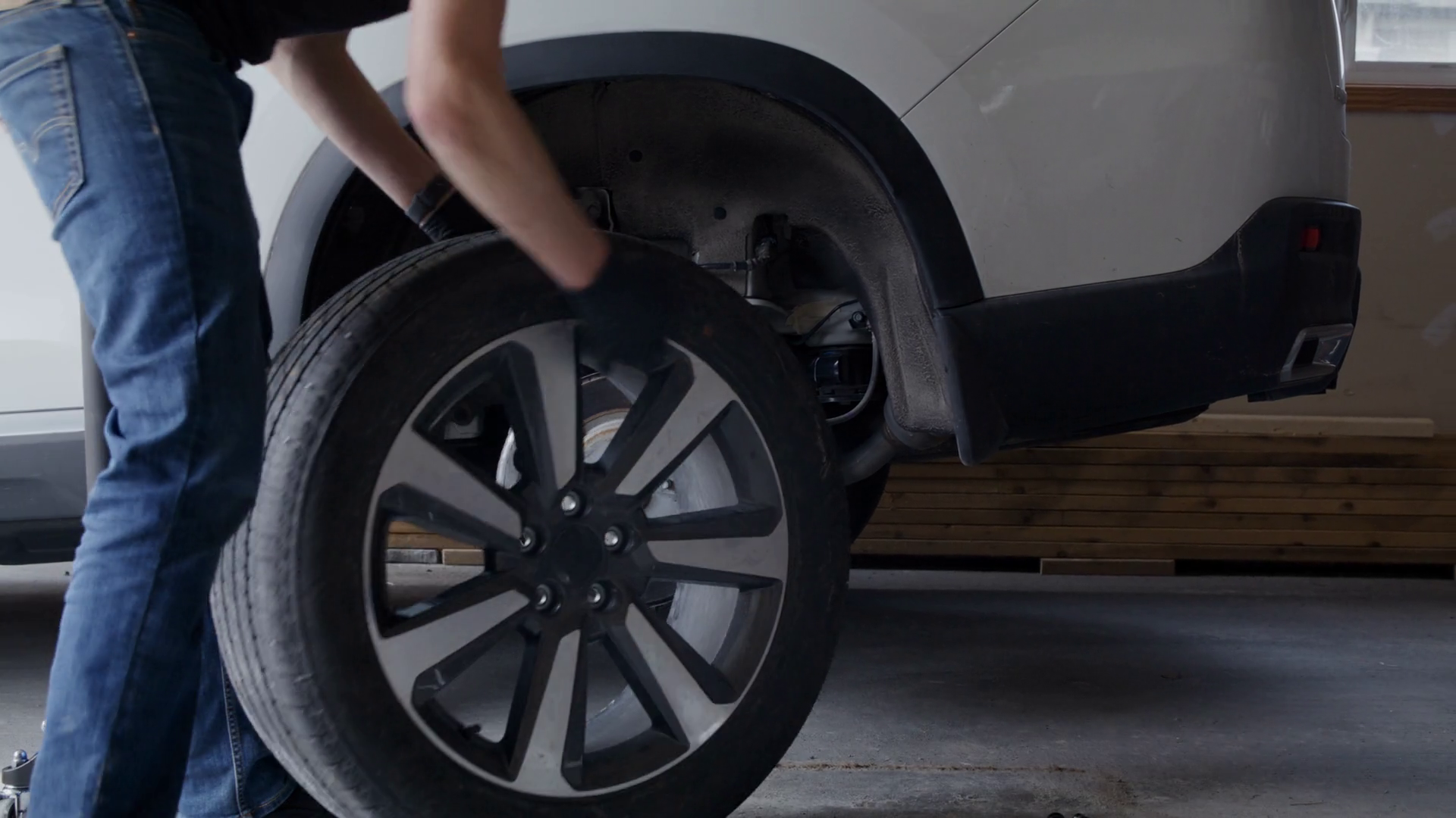 Man Rolls Summer Car Wheel Into Position On Stock Footage SBV-352115178 ...