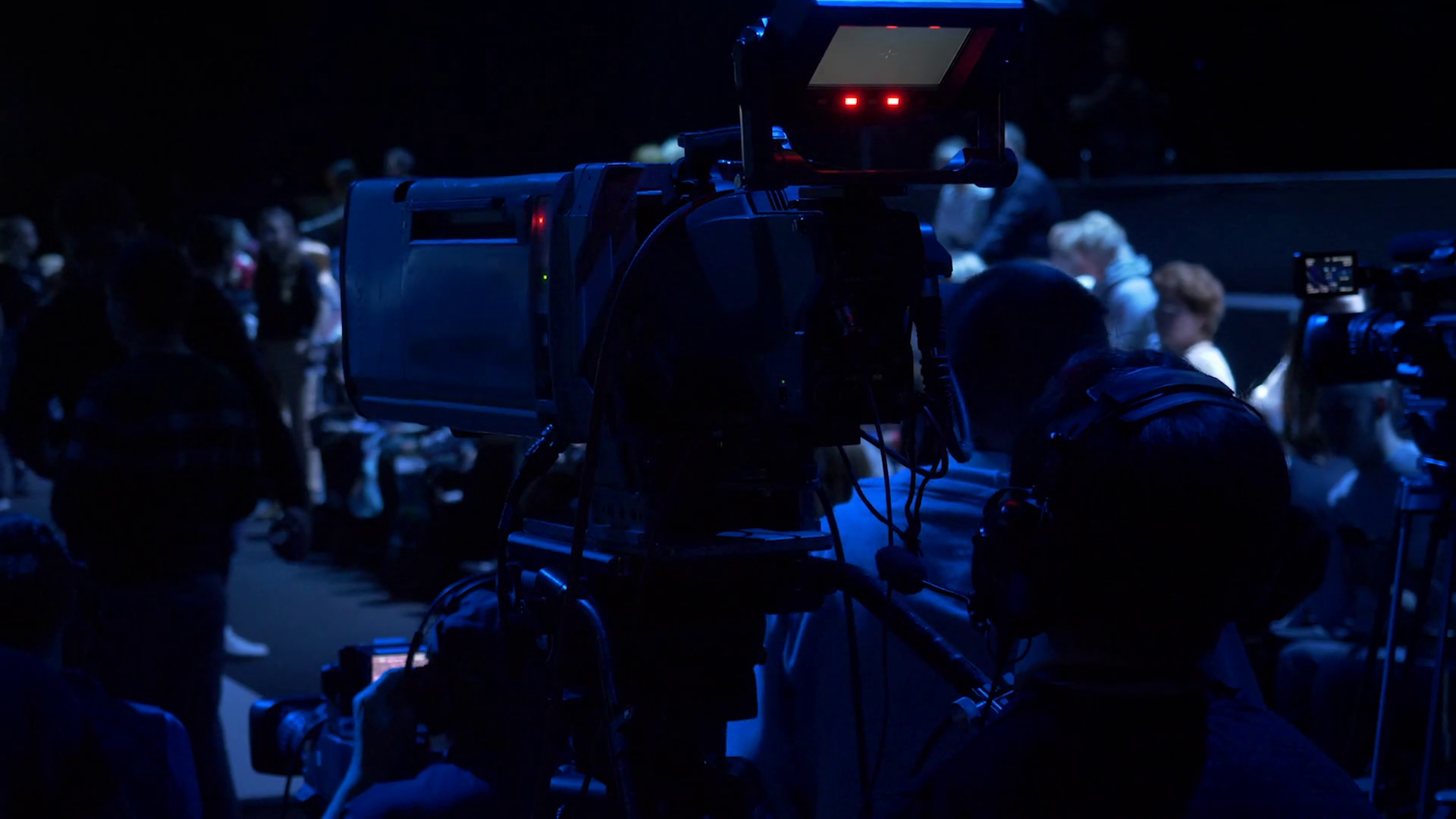 Videographer shooting video for television show in studio. Cameraman ...