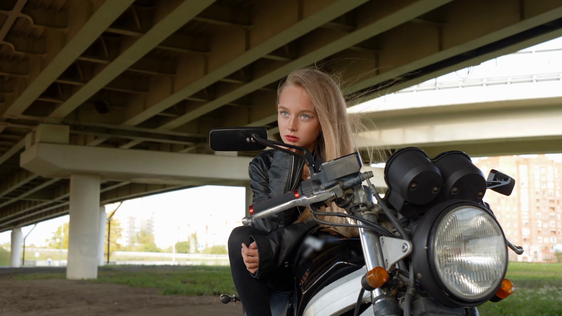 Young girl biker in leather jacket sitting on parking motorcycle on ...