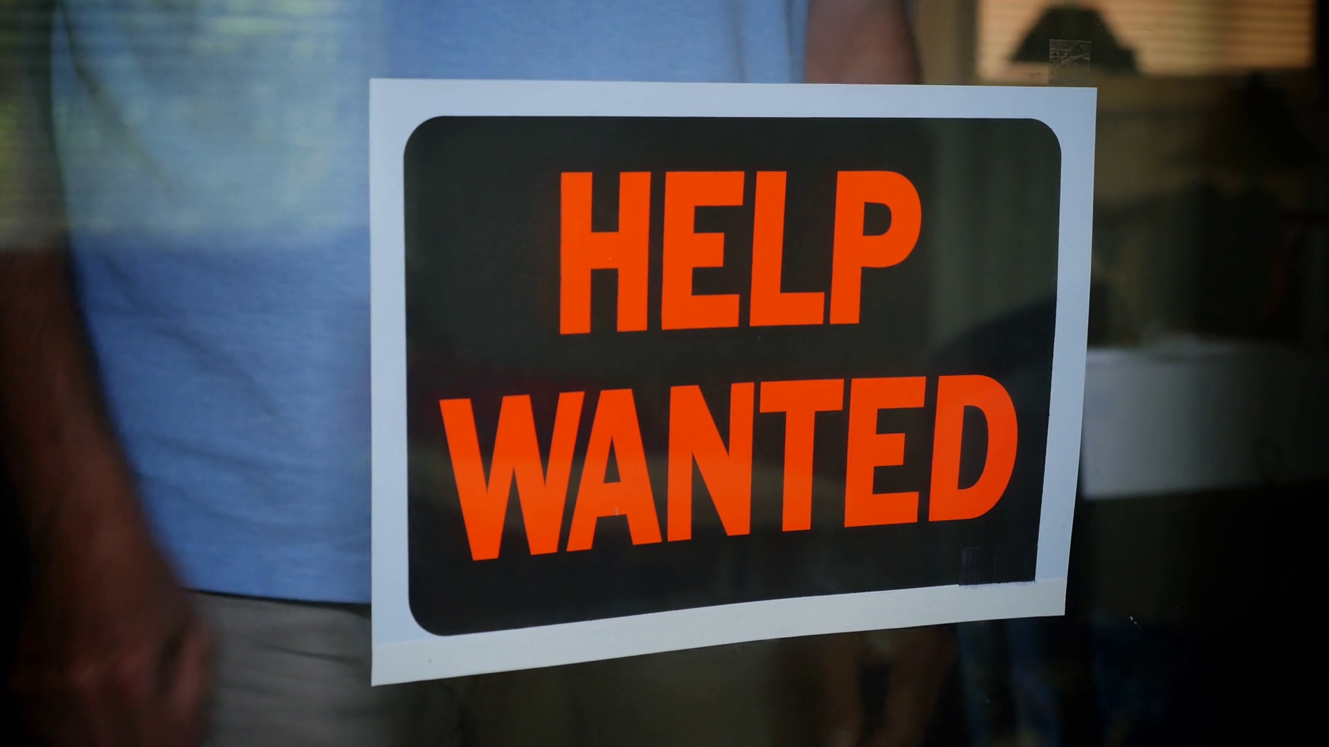 A Shop Owner Places Help Wanted Sign In Stock Footage SBV-301994813 ...
