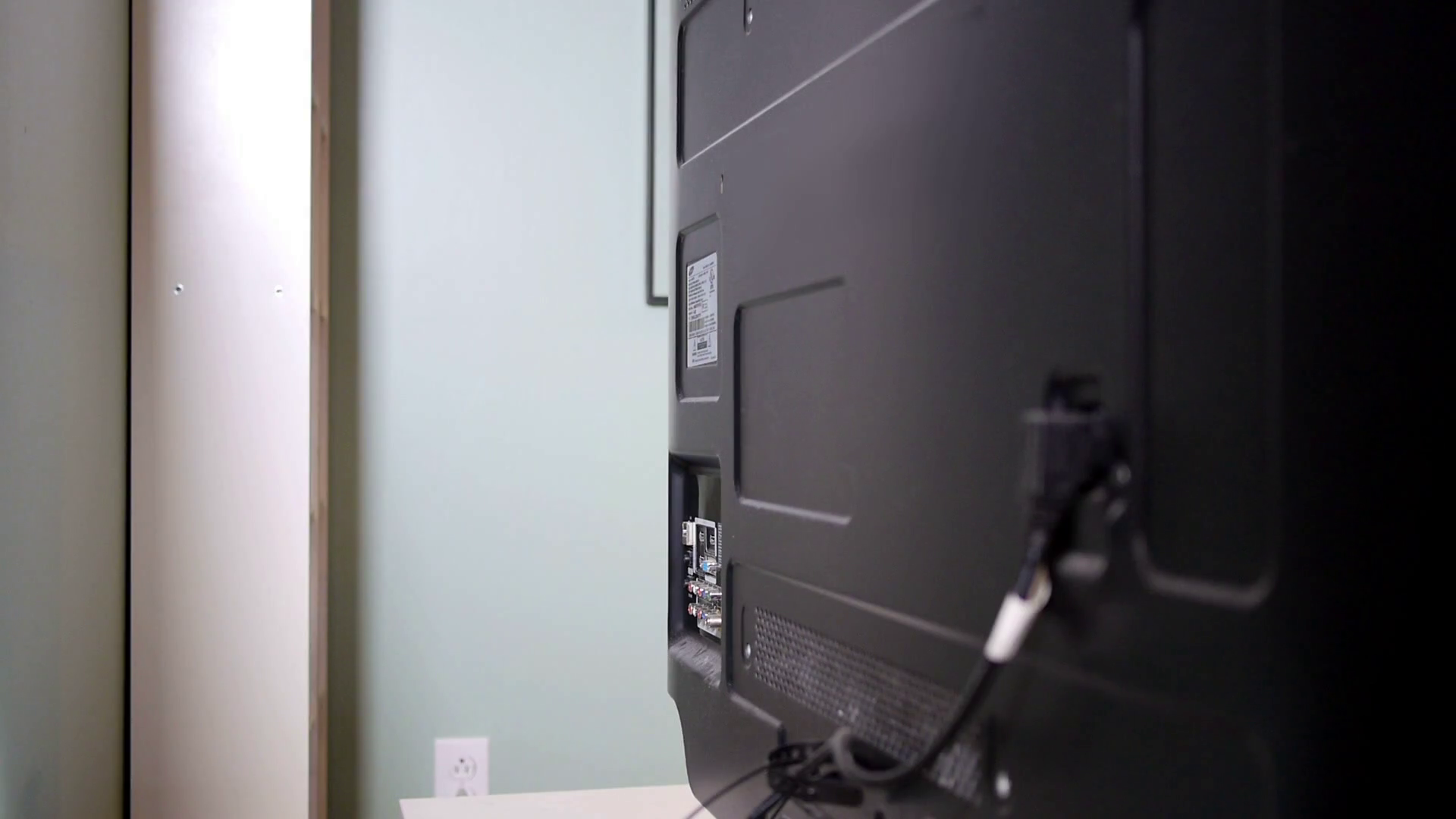 Cable Television Installer Plugs Cable into Back of Flatscreen Living ...