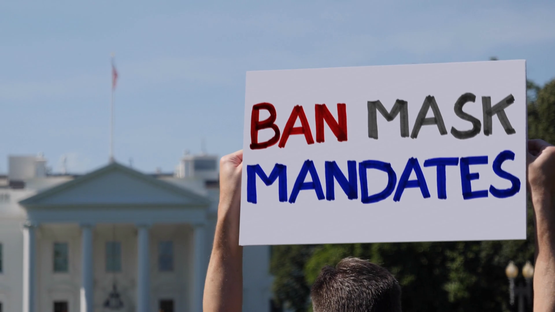 A Man Holds Ban Mask Mandates Protest Sign Stock Footage SBV-346782575 ...