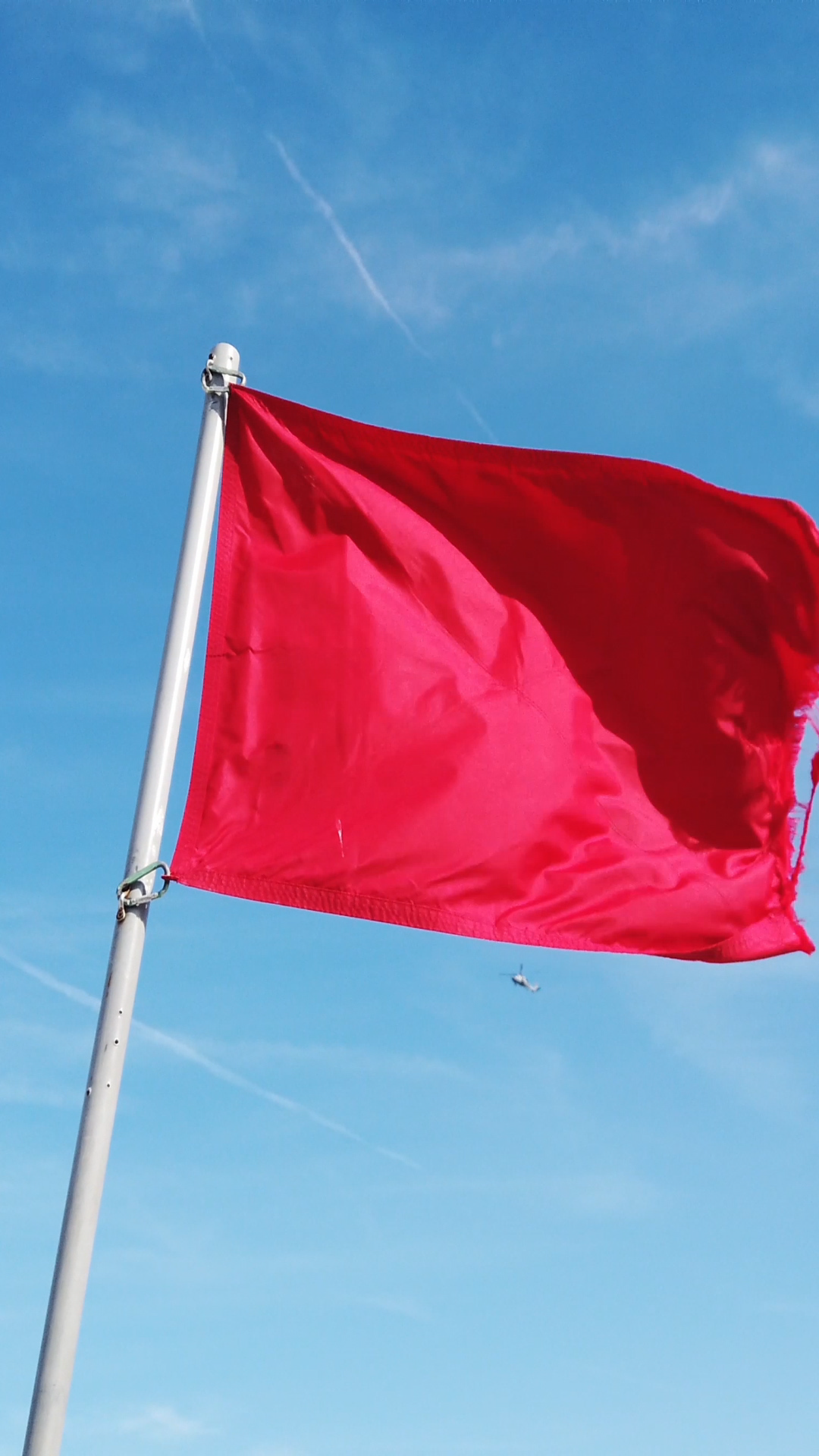 A Vertical Slow-motion View Of Red Flag Stock Footage SBV-353075550 ...