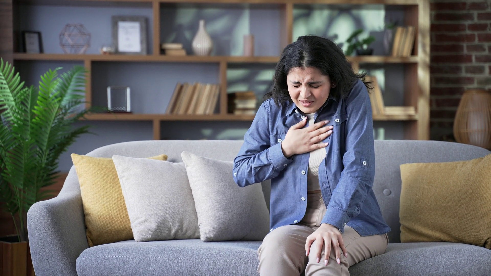 Young Woman Has Heart Attack Sitting On Sofa Stock Footage SBV ...