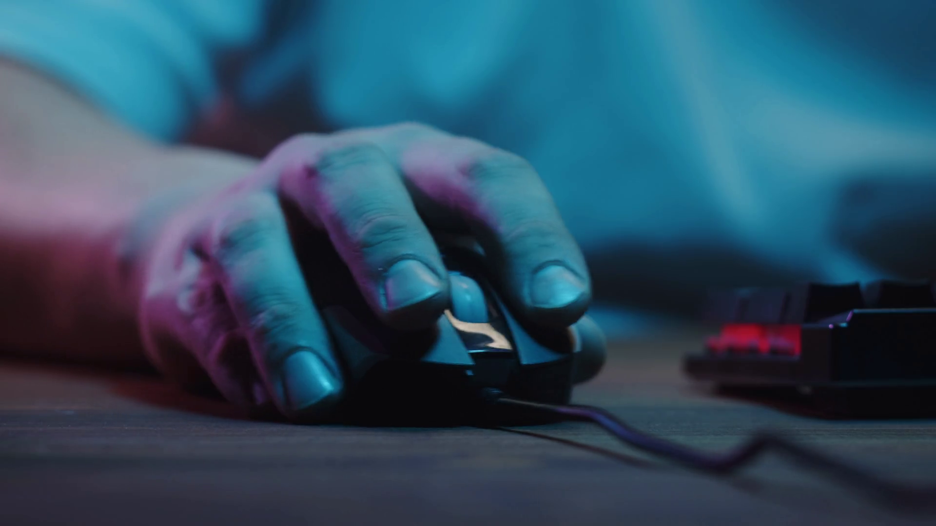Gamer typing on backlight keyboard close-up, man playing video game ...