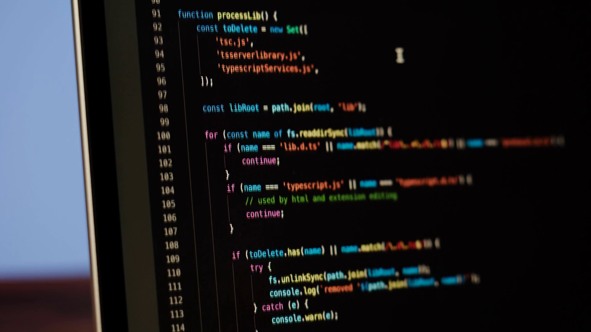 Programmer using laptop. Program code and script data on the screen ...