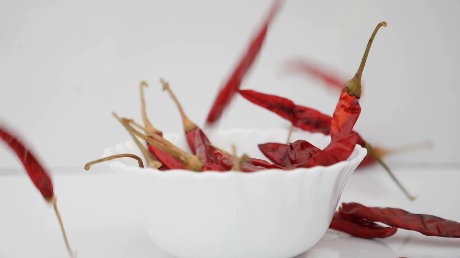 Red Dried Chilli Pepers Falling Into White Stock Footage SBV-338773122 ...