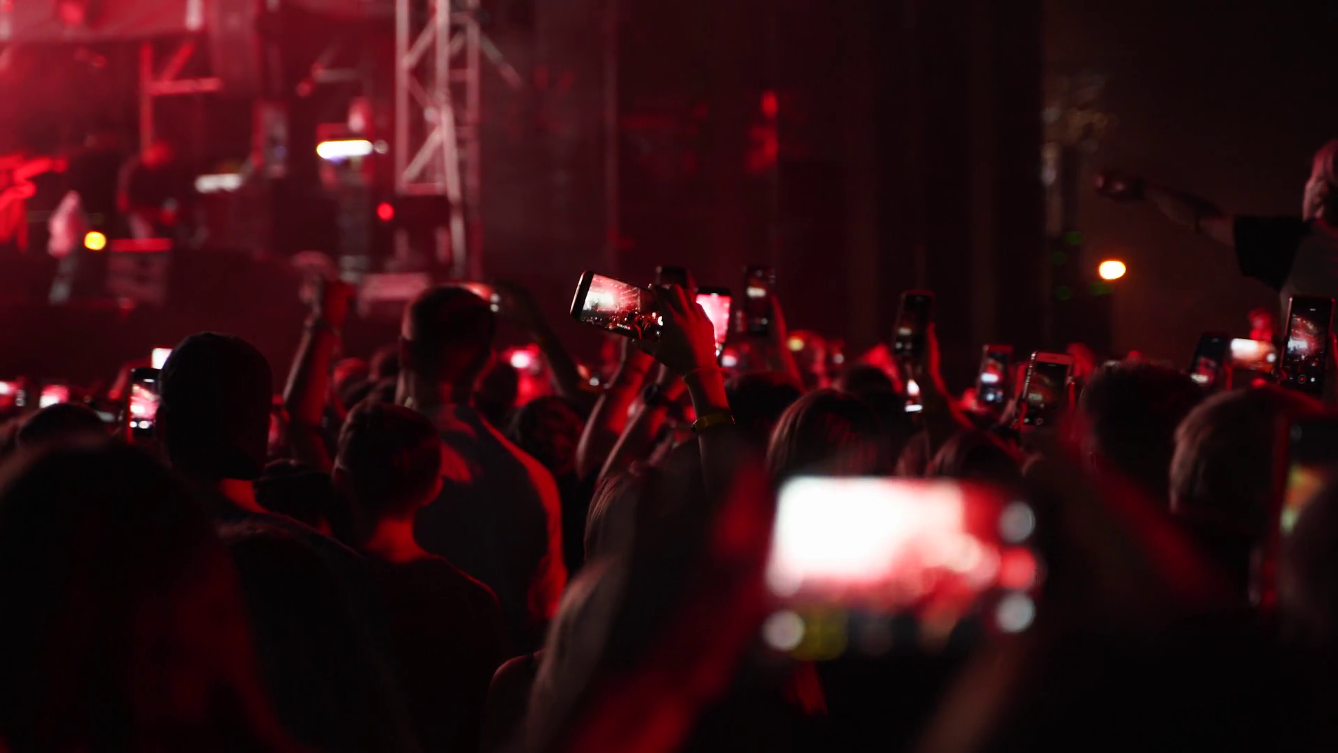 People silhouettes waving hands, taking photos or recording videos of ...
