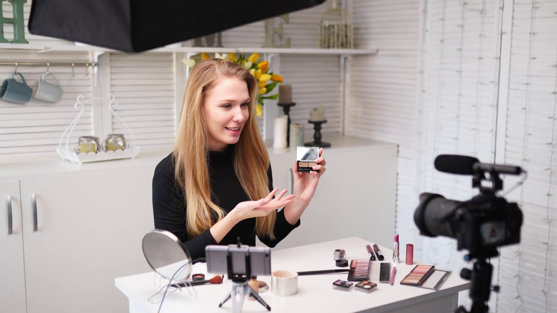 Beauty blogger woman filming daily makeup routine tutorial near camera ...