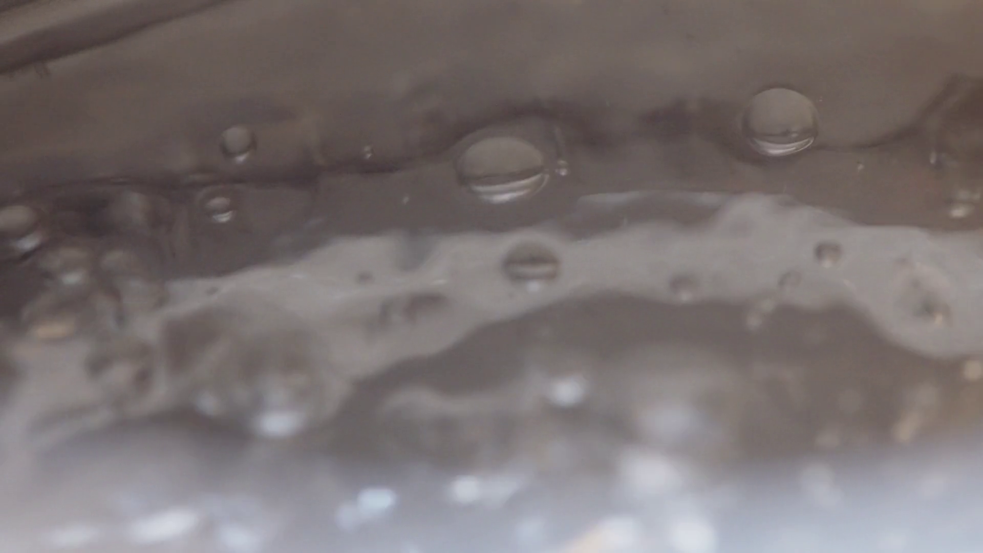 Close-up Of Boiling Water Bubbles In Dish Stock Footage SBV-348673459 ...
