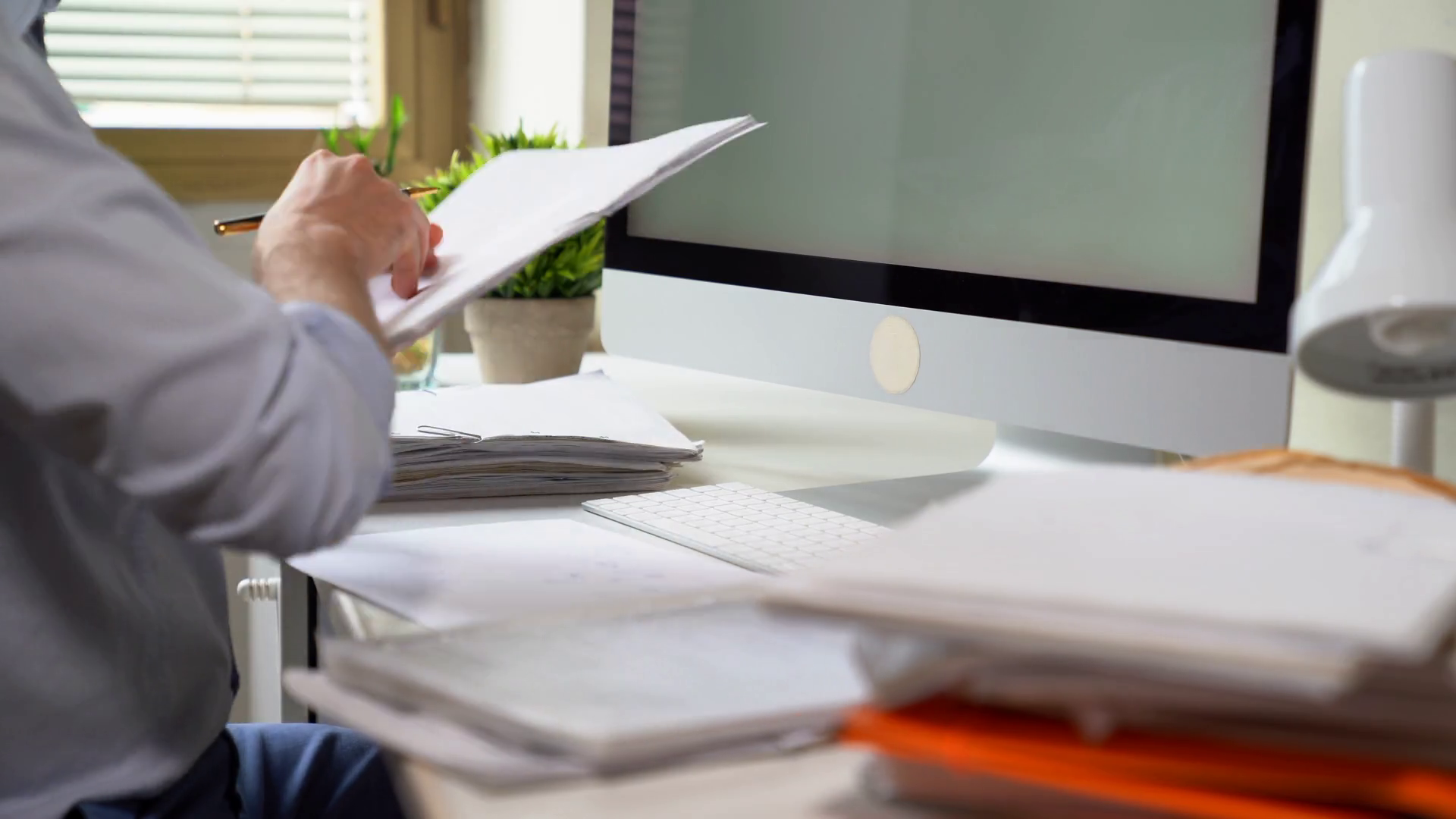 Businessman reading paperwork at desk in office. Office clerk work with ...