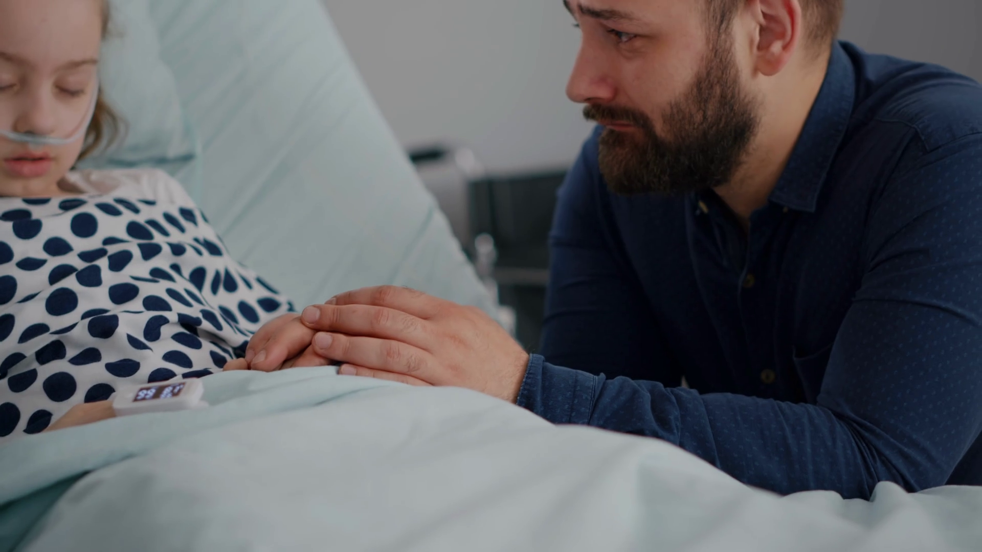 Worried emotional father crying beside sick daughter waiting for ...