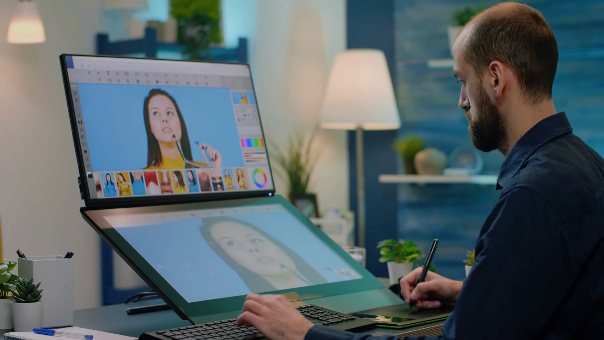 Photography artist editing photos with graphic tablet and stylus while ...