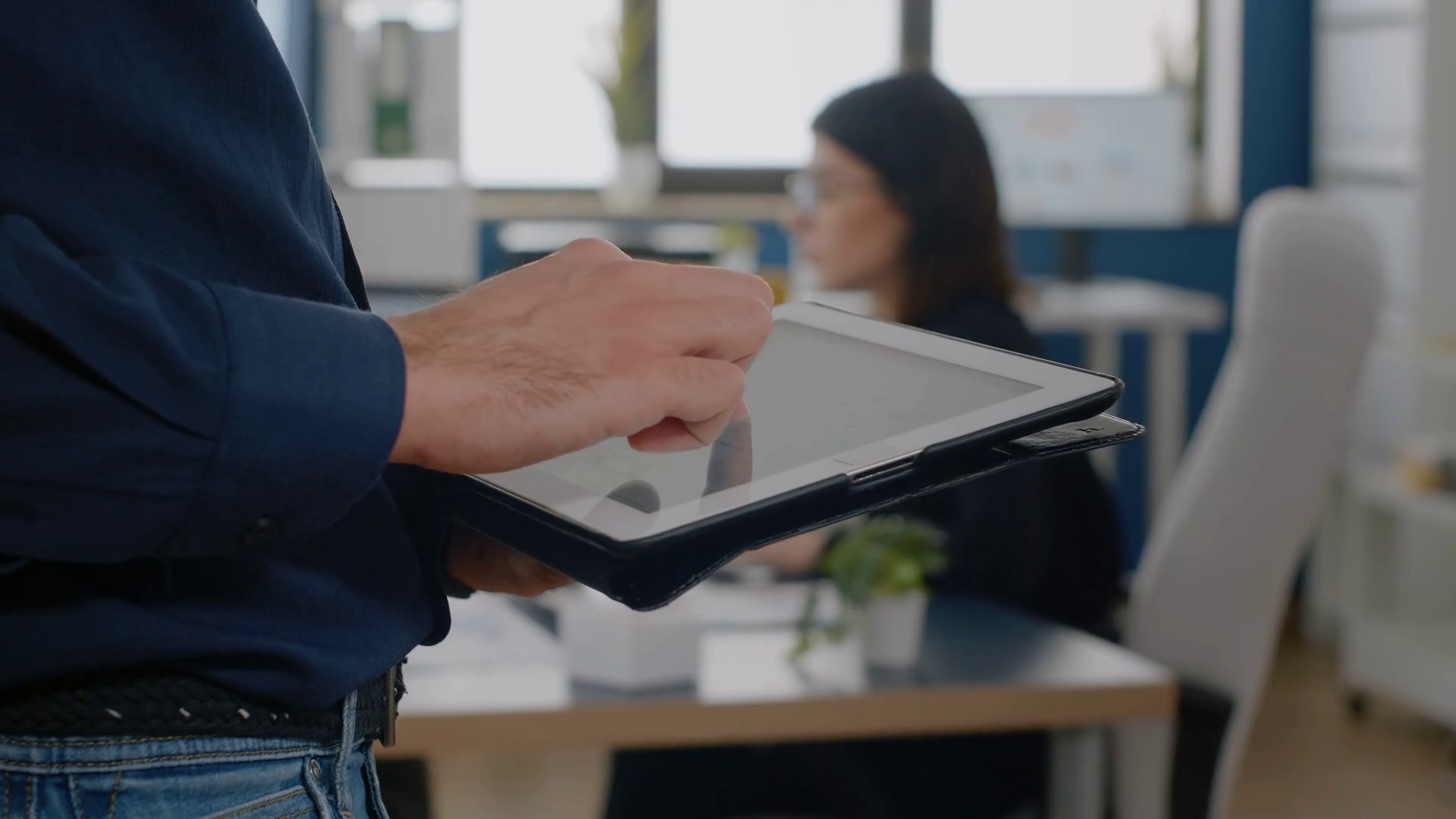 Close up of man using digital tablet for business project at corporate ...