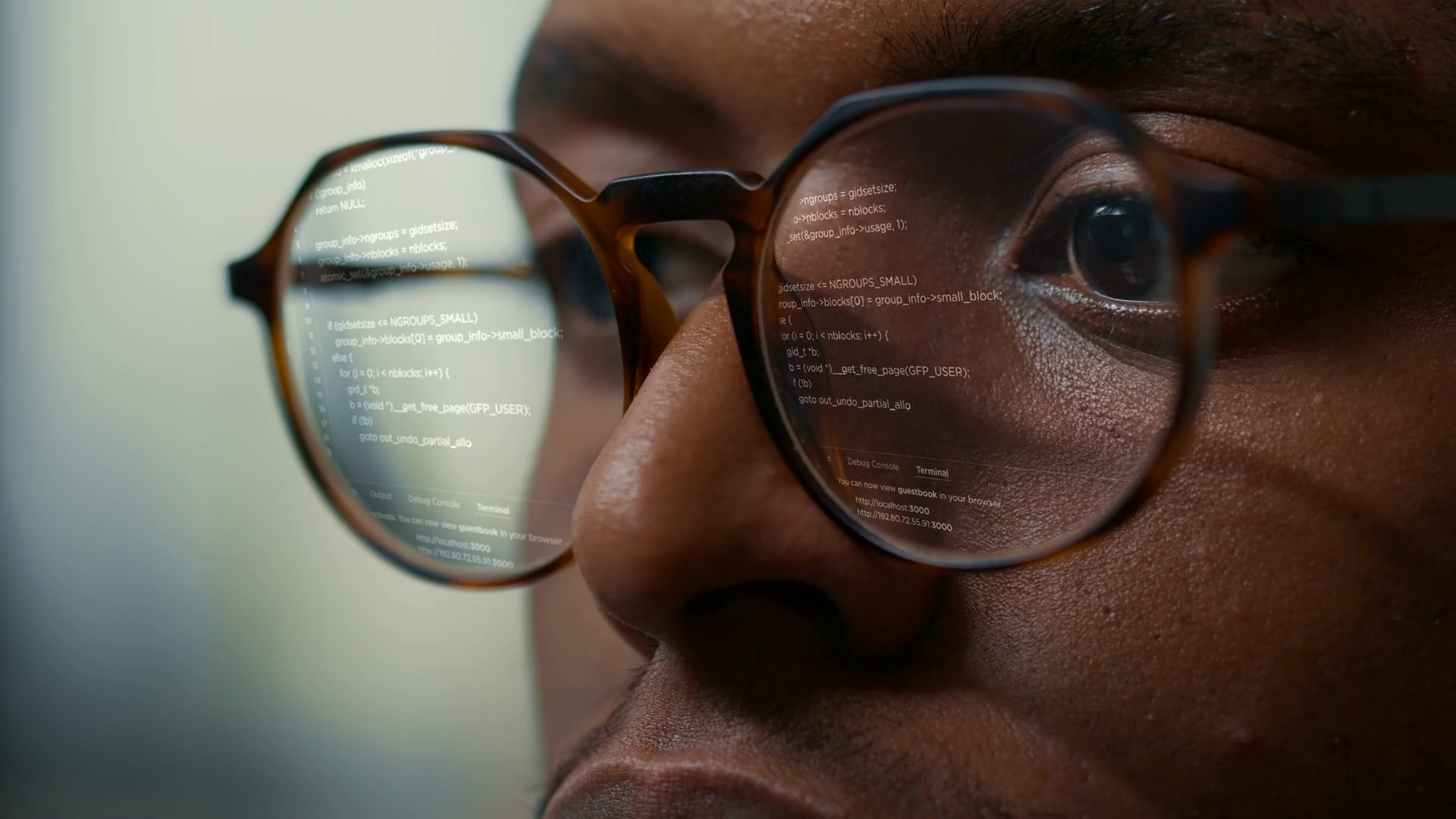Vfx of running programming code reflected in software developer glasses ...